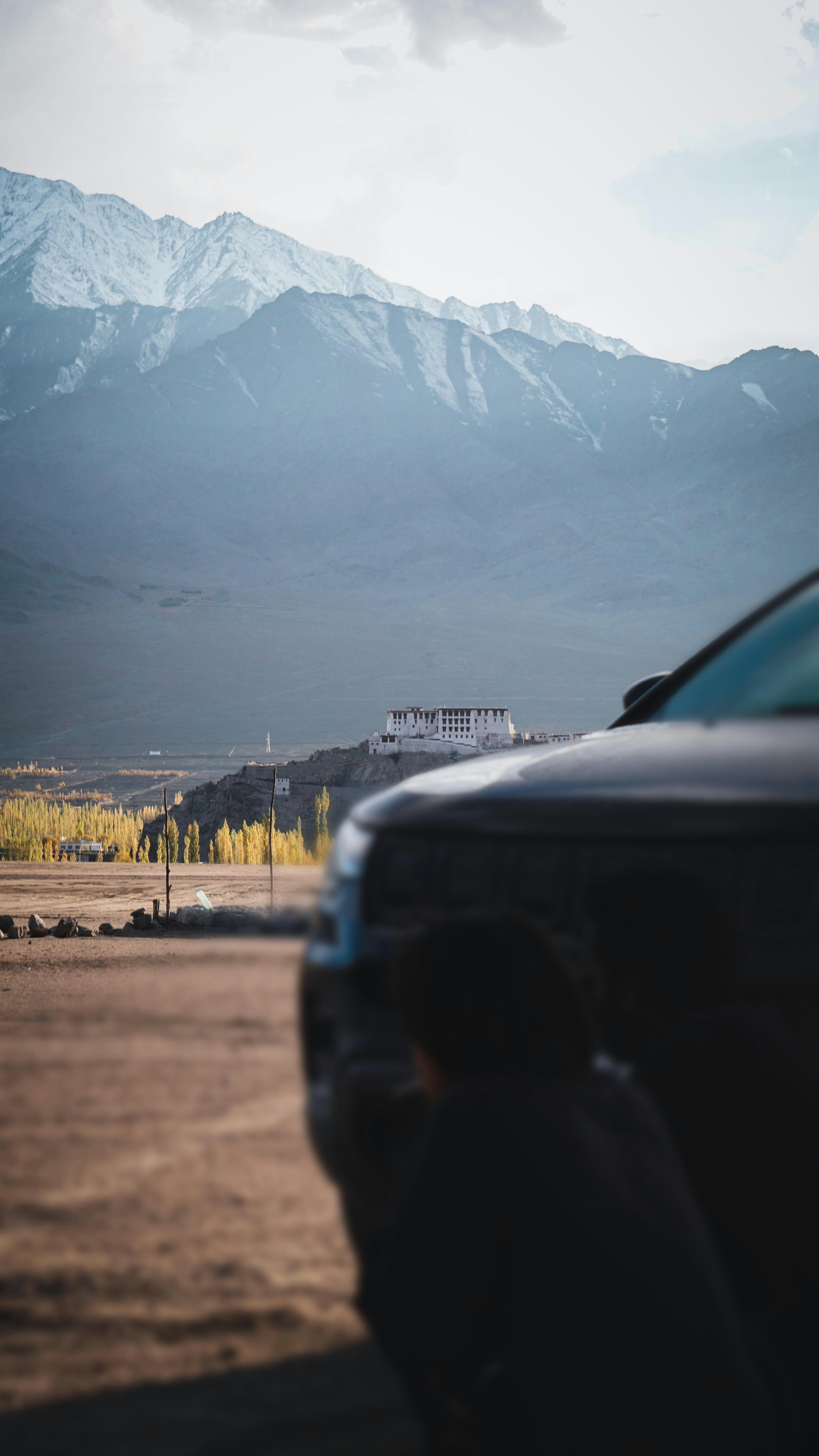 Shadowed Camper at the Foot of Snowy Peaks