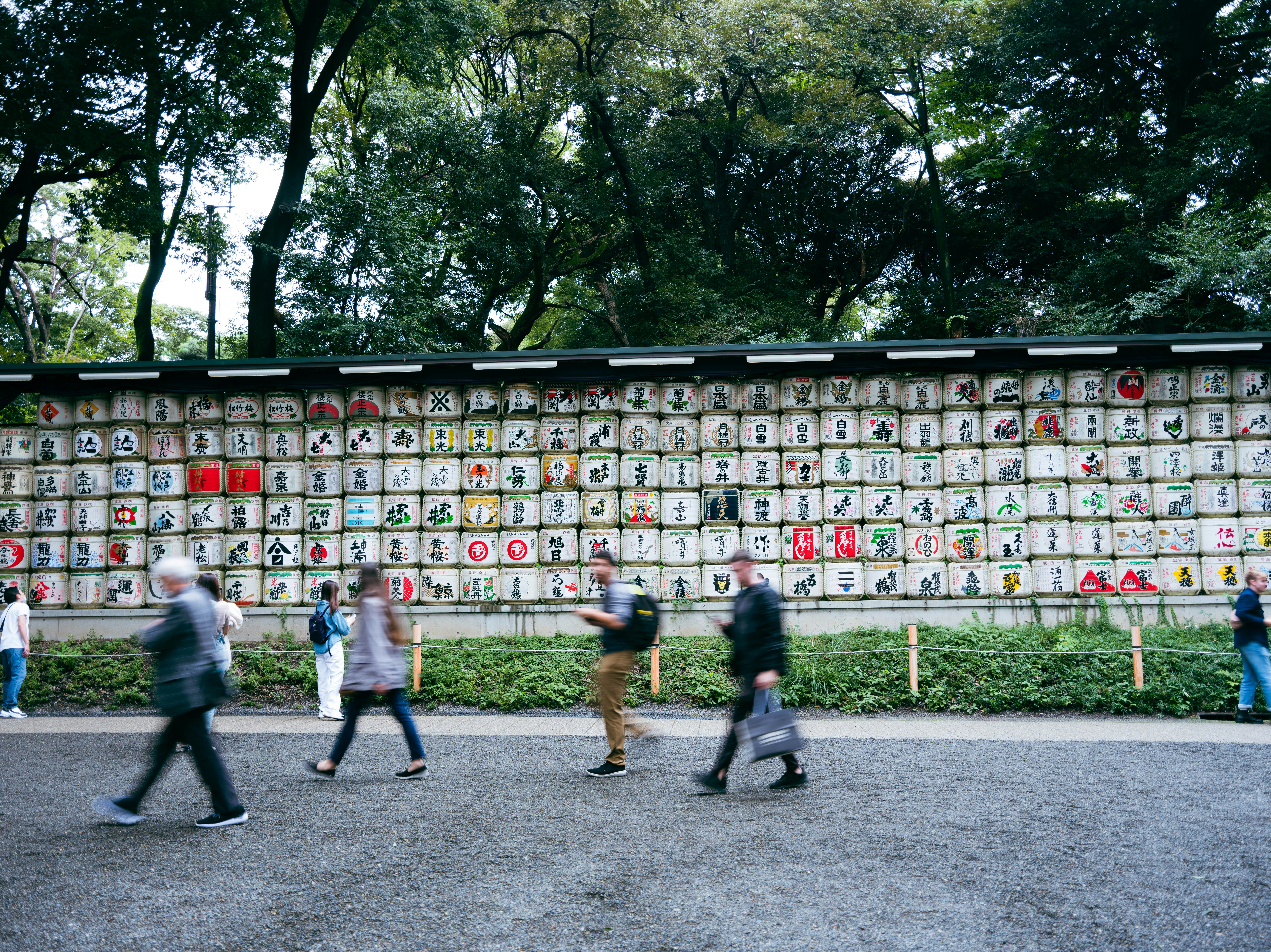 Whispering Tiles: A Wall of Shrine Plaques Framed by Blurred Footsteps