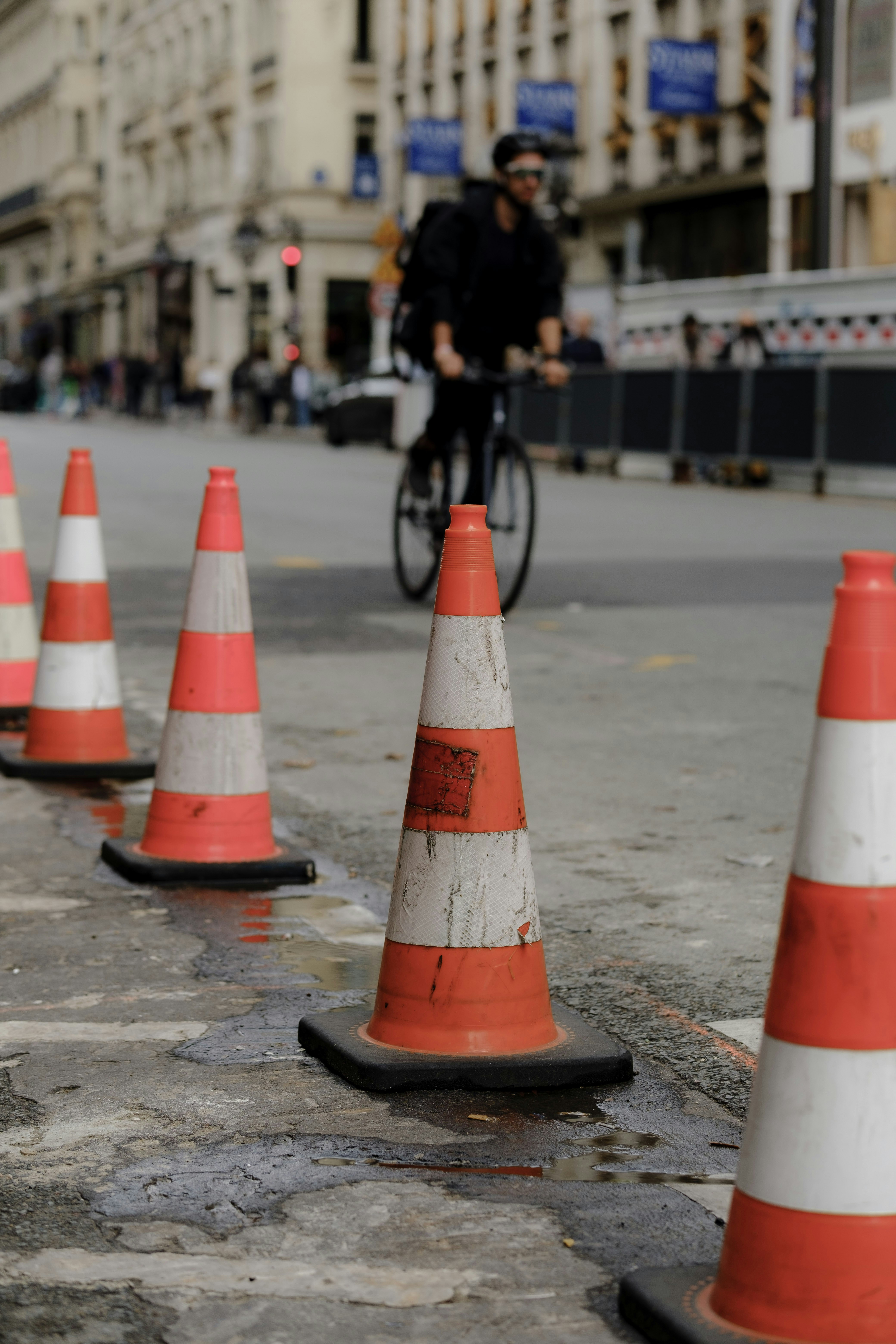 A person riding a bicycle through traffic cones photo – Free Paris ...