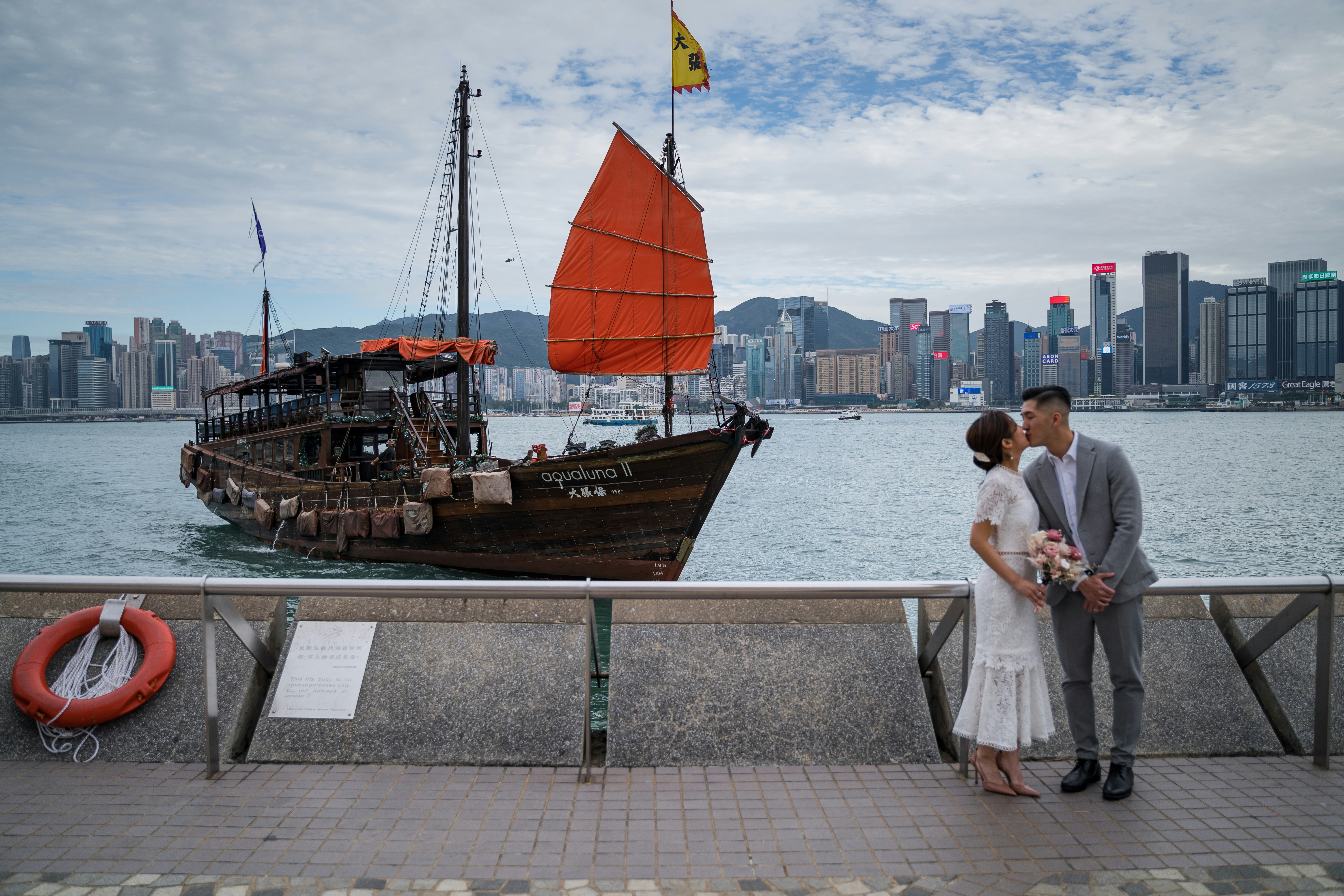 A couple stands in front of a large boat photo – Free Human Image on ...