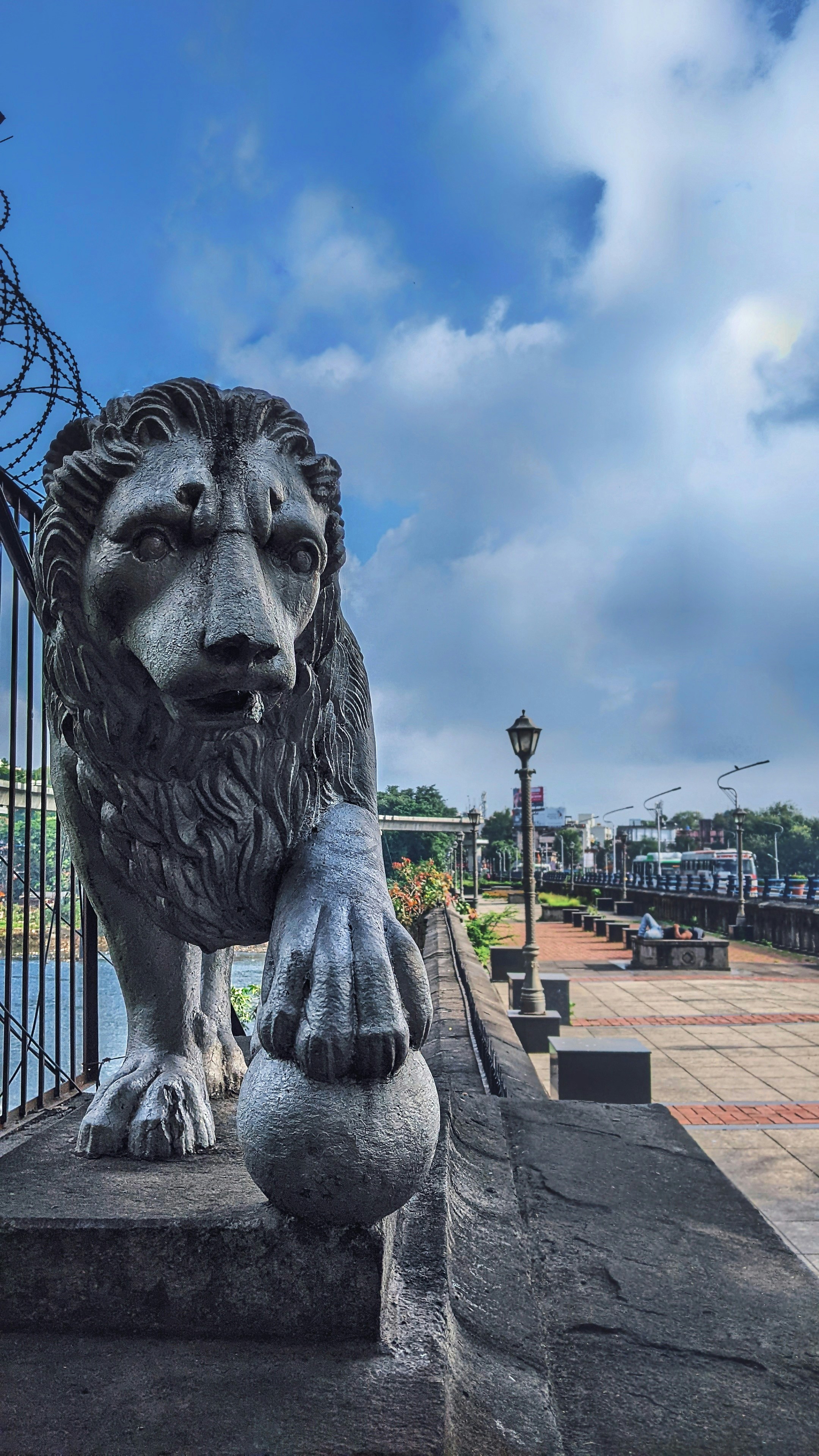 Quayside Guardian: A Stone Lion Stares Toward the River
