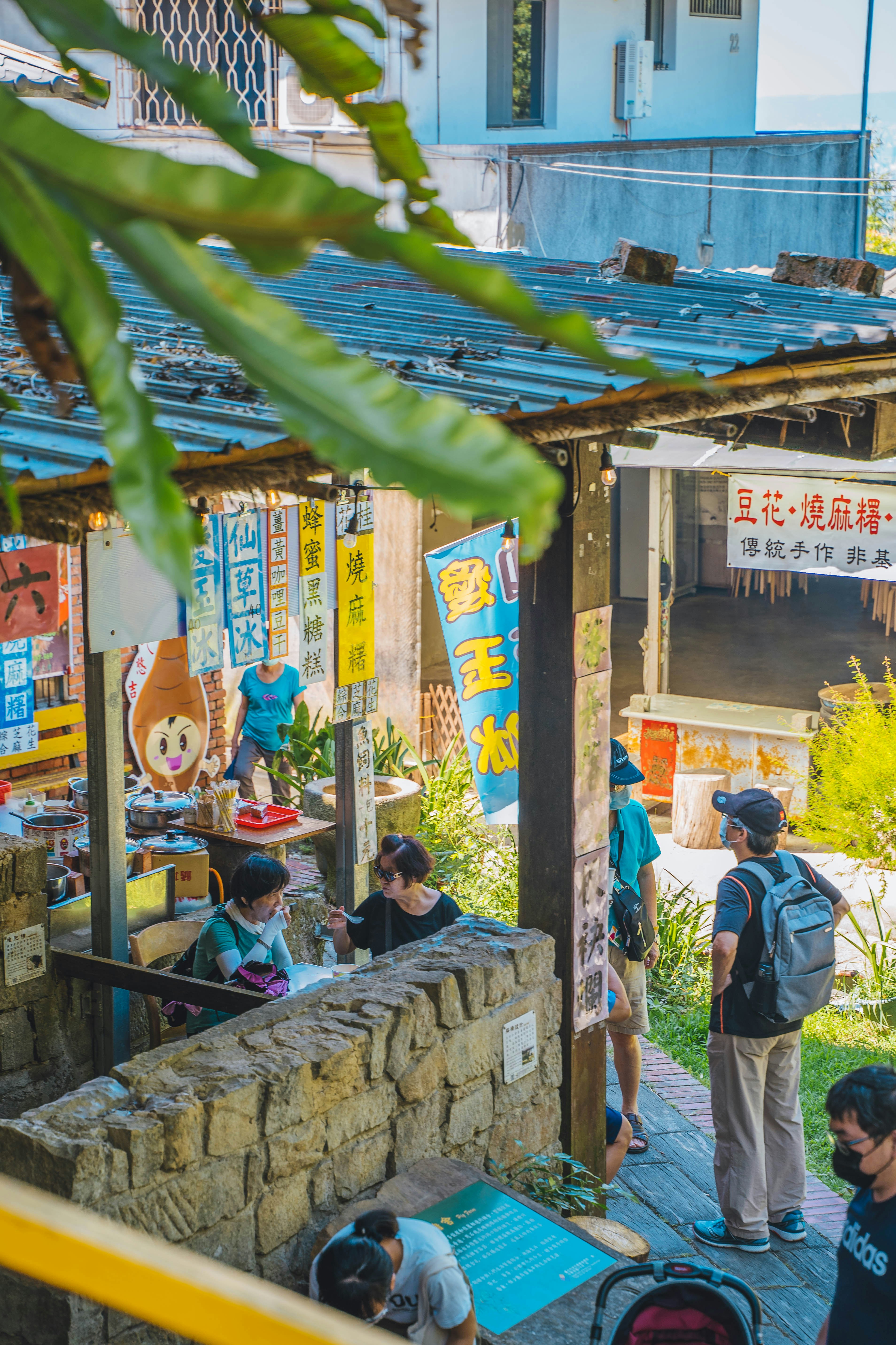 Market Banter Under Colorful Banners