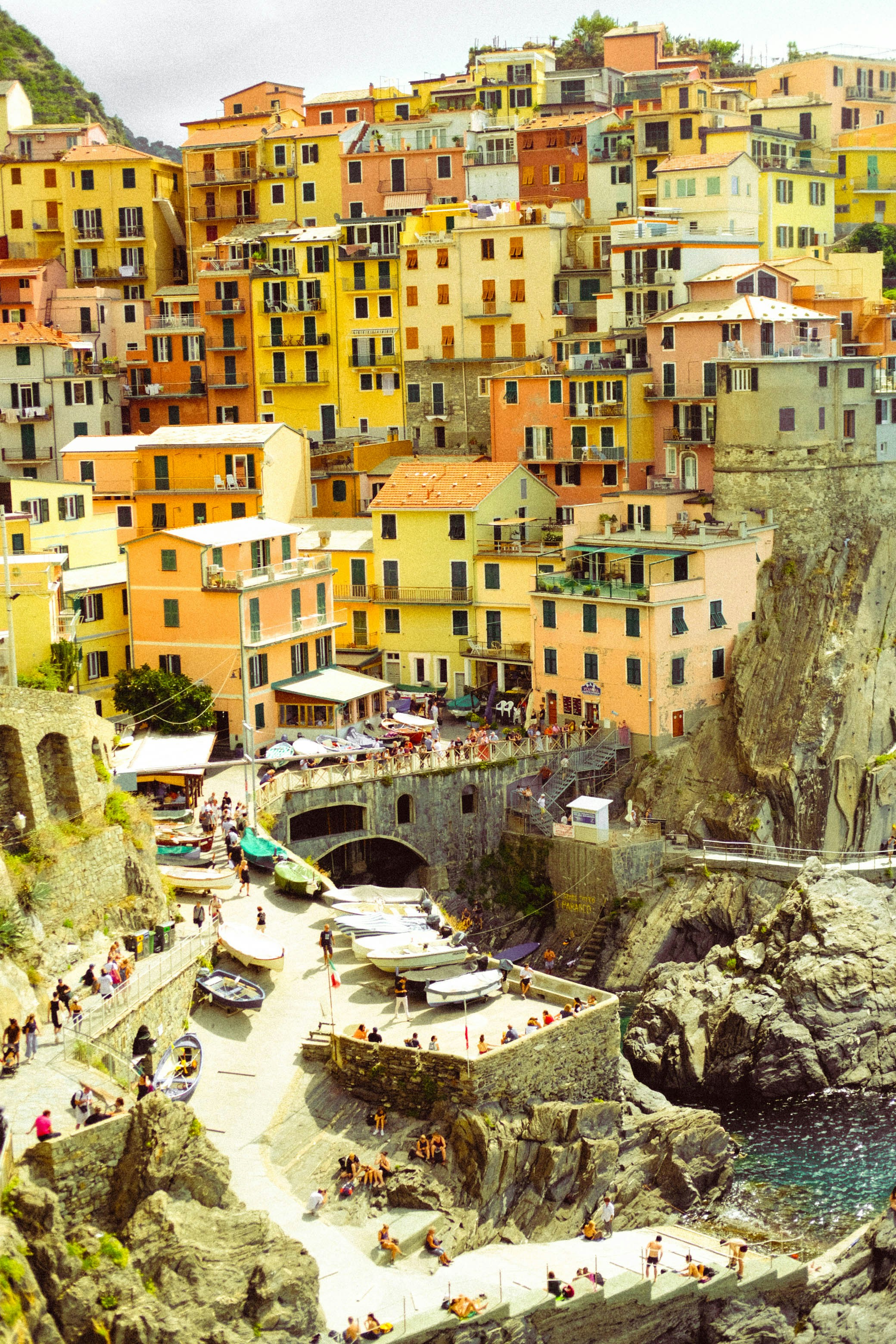 Vibrant hillside village cascade over rocky harbor