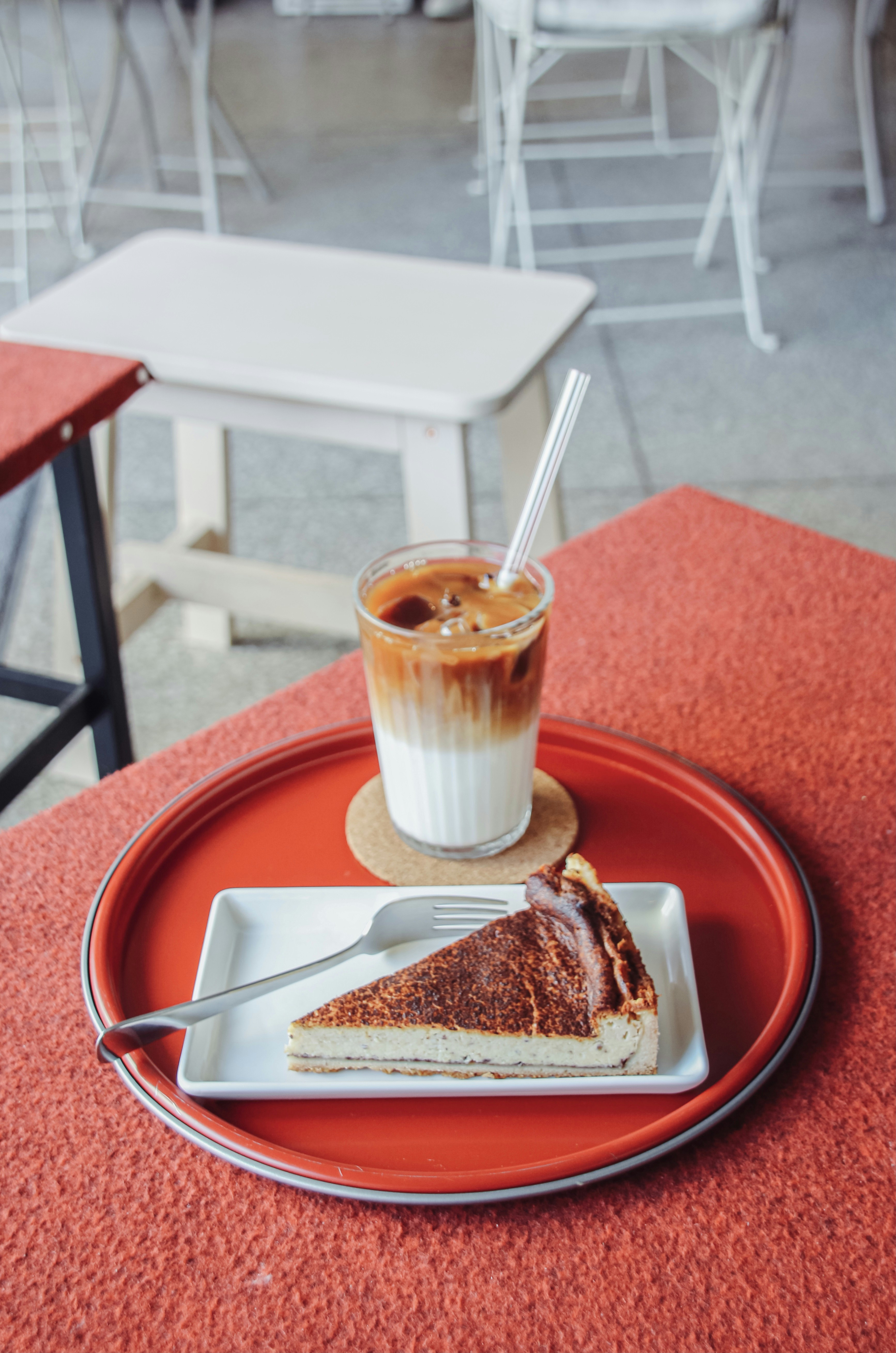 Crimson Tray Café: Cheesecake Slice and Iced Coffee in a Sunlit Still Life