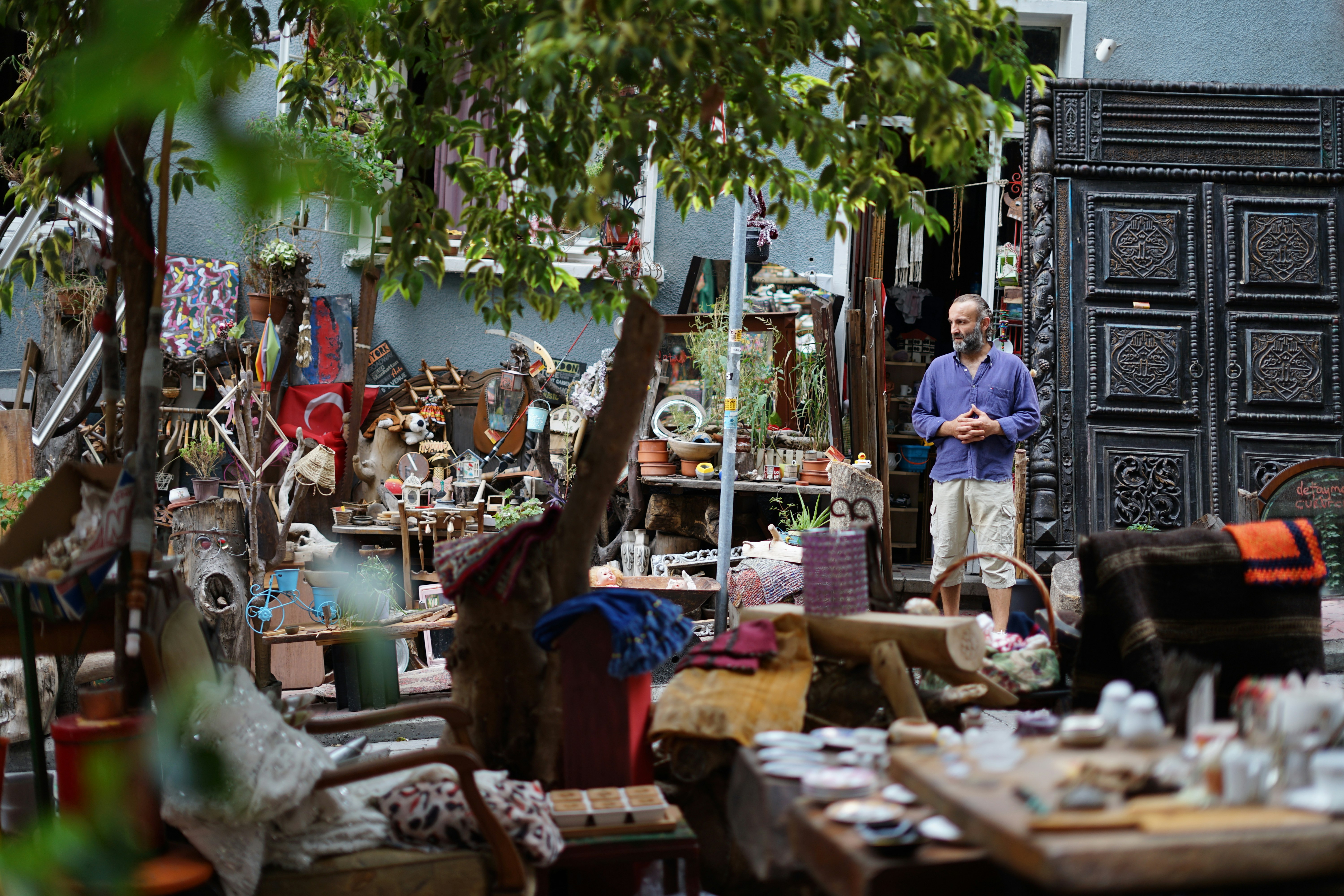 A person standing next to a pile of junk photo – Free Istanbul Image on ...