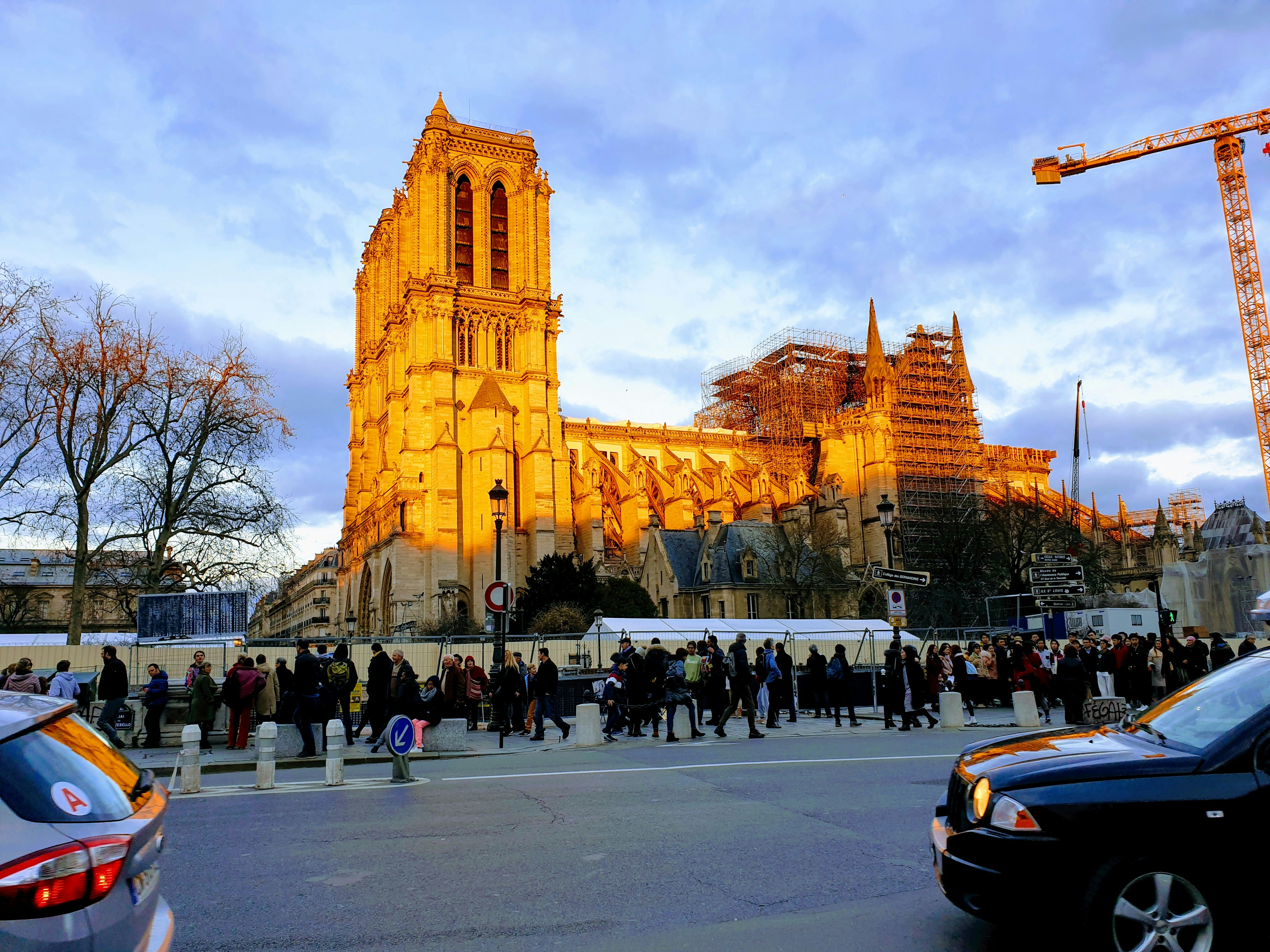 Golden Cathedral: Sunlit Facade Amid City Street Gathering