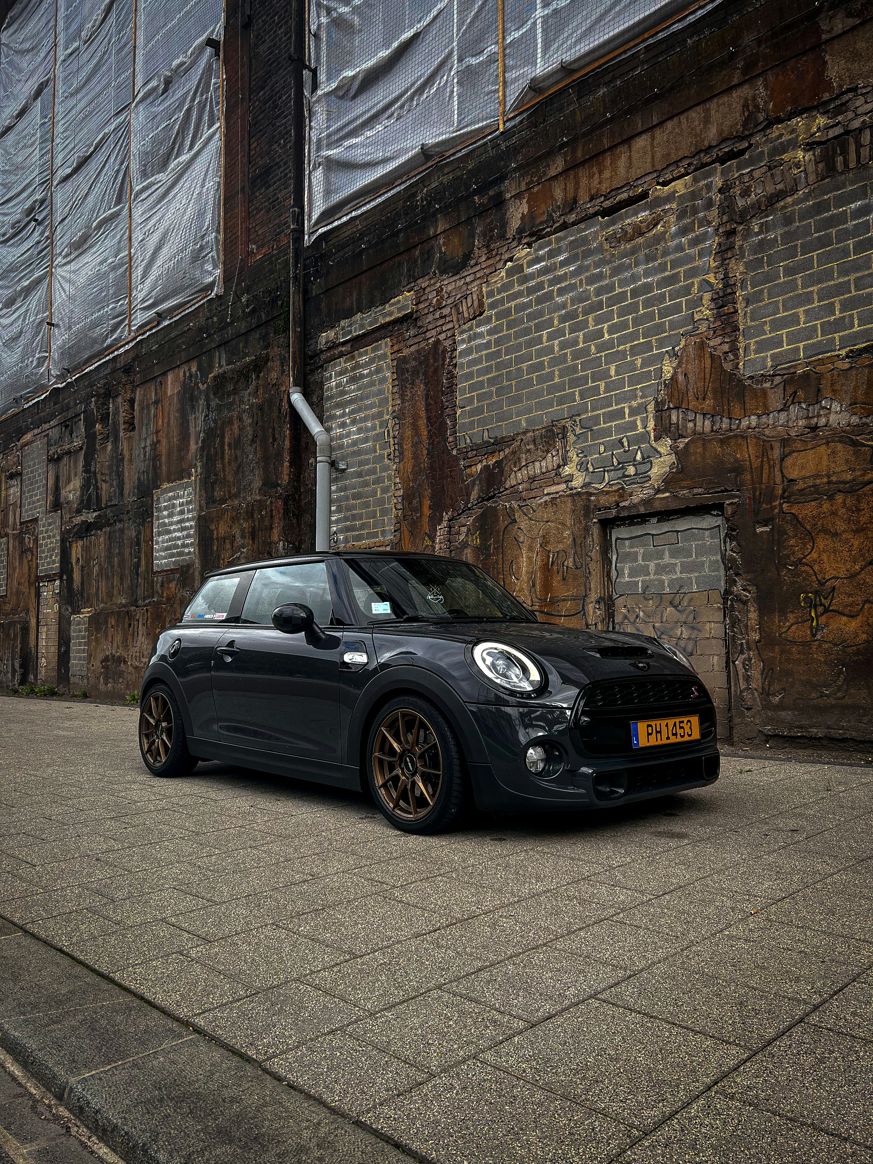 Urban Noir: A Compact Classic Resting by the Brickwork