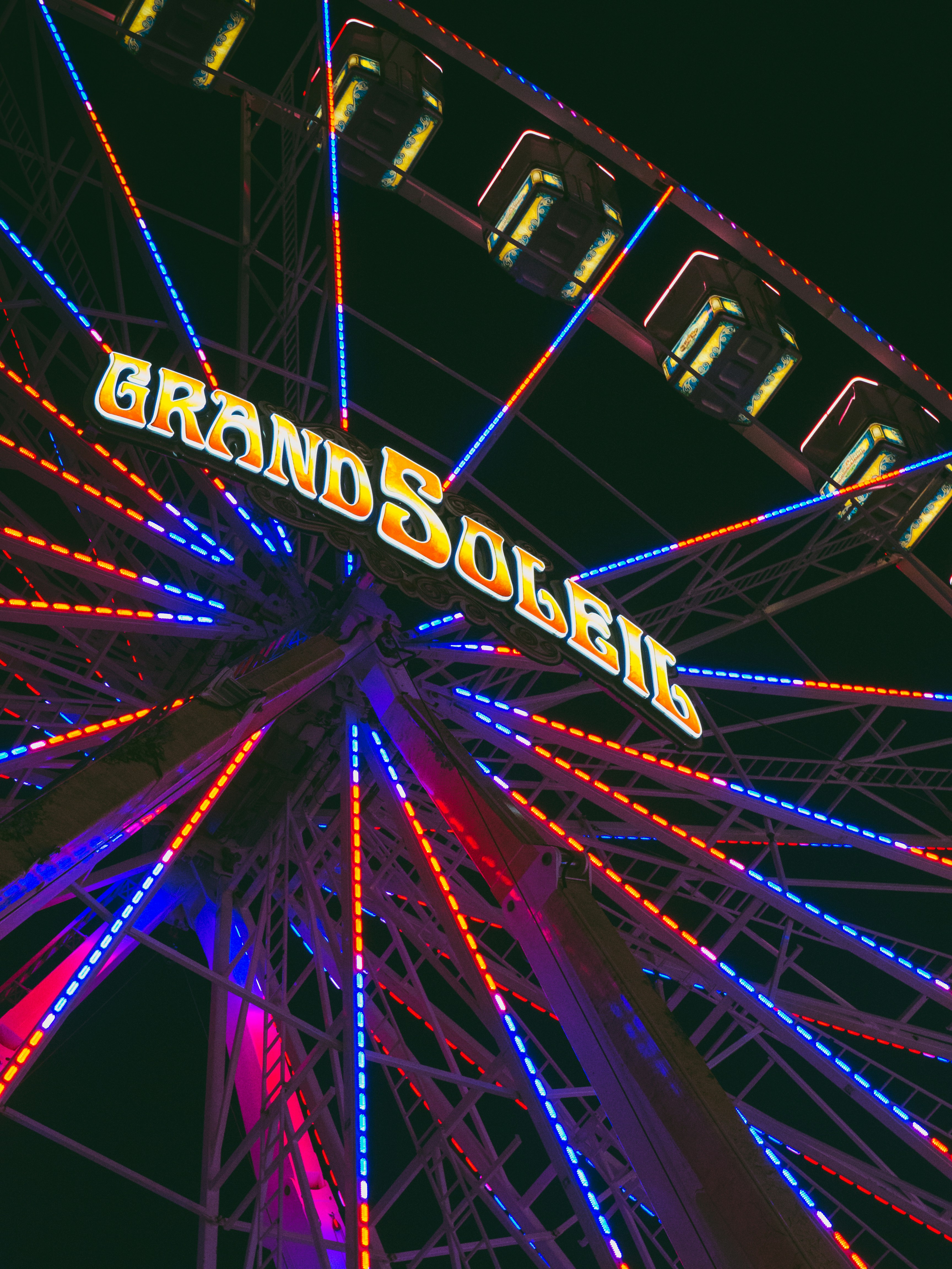 Neon Wheel: Grinning Ferris Wheel Lights Spin in Night