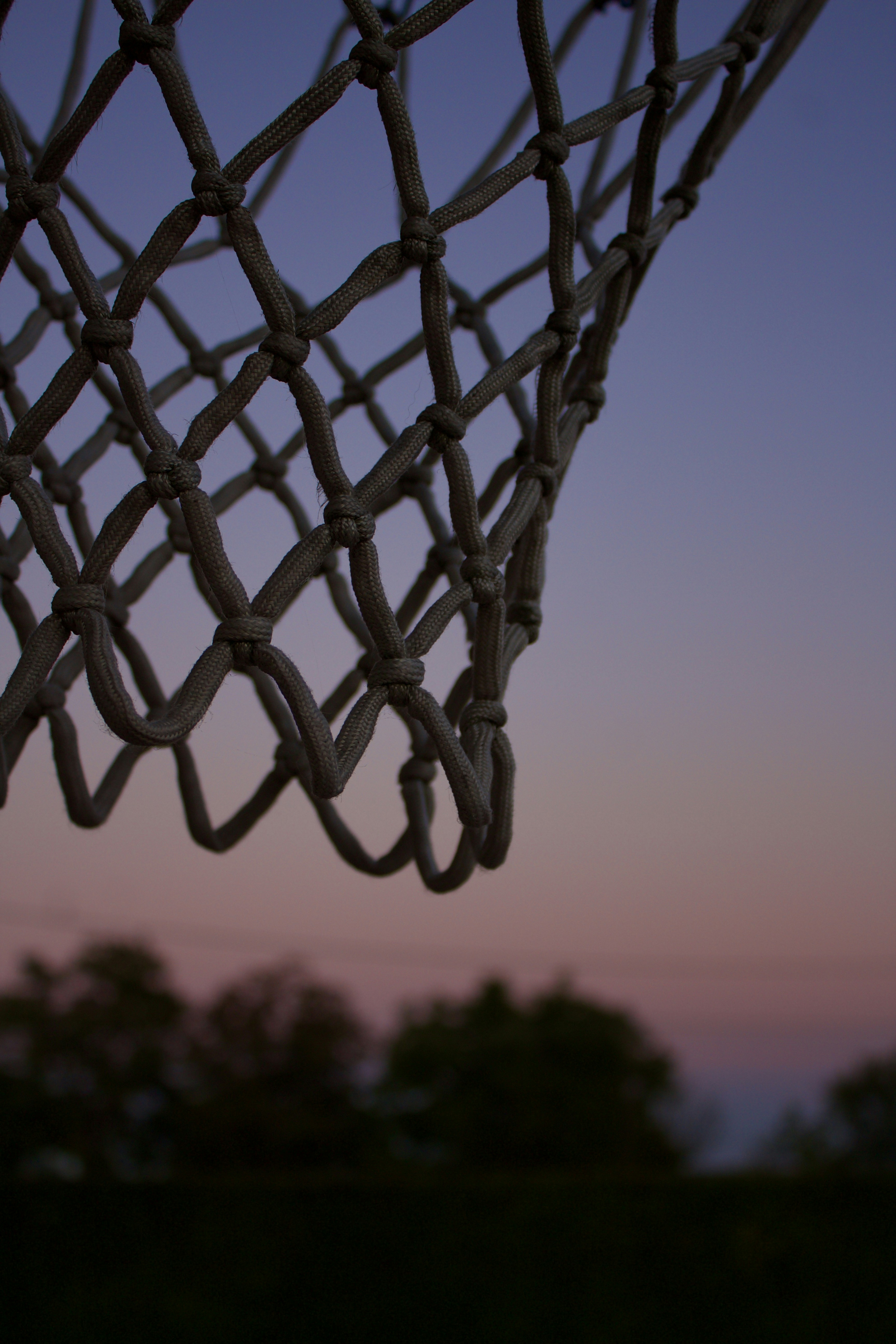 Basketball net with sunset in the background