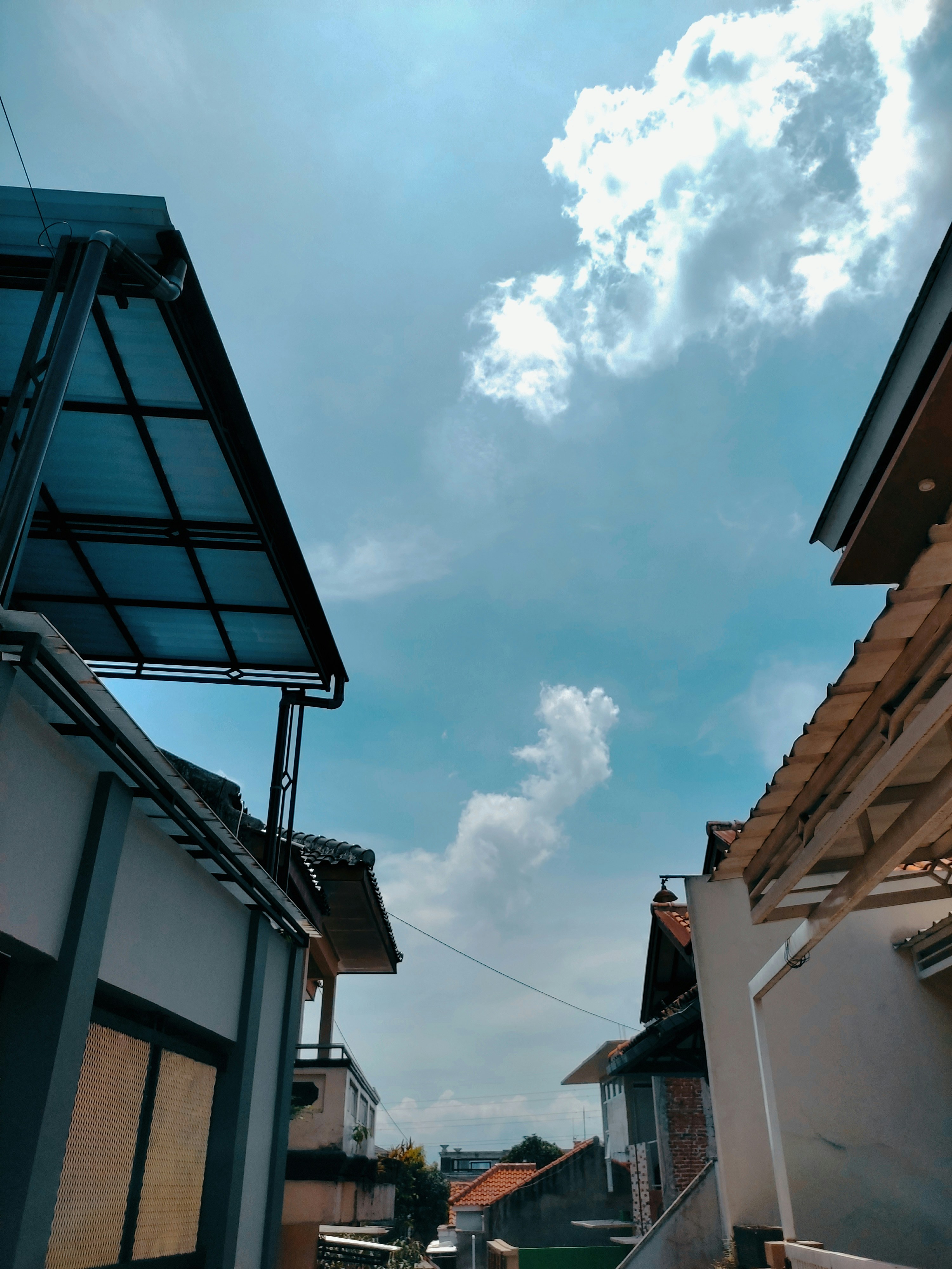 Between Rooftops and Sky: A Cerulean Noon