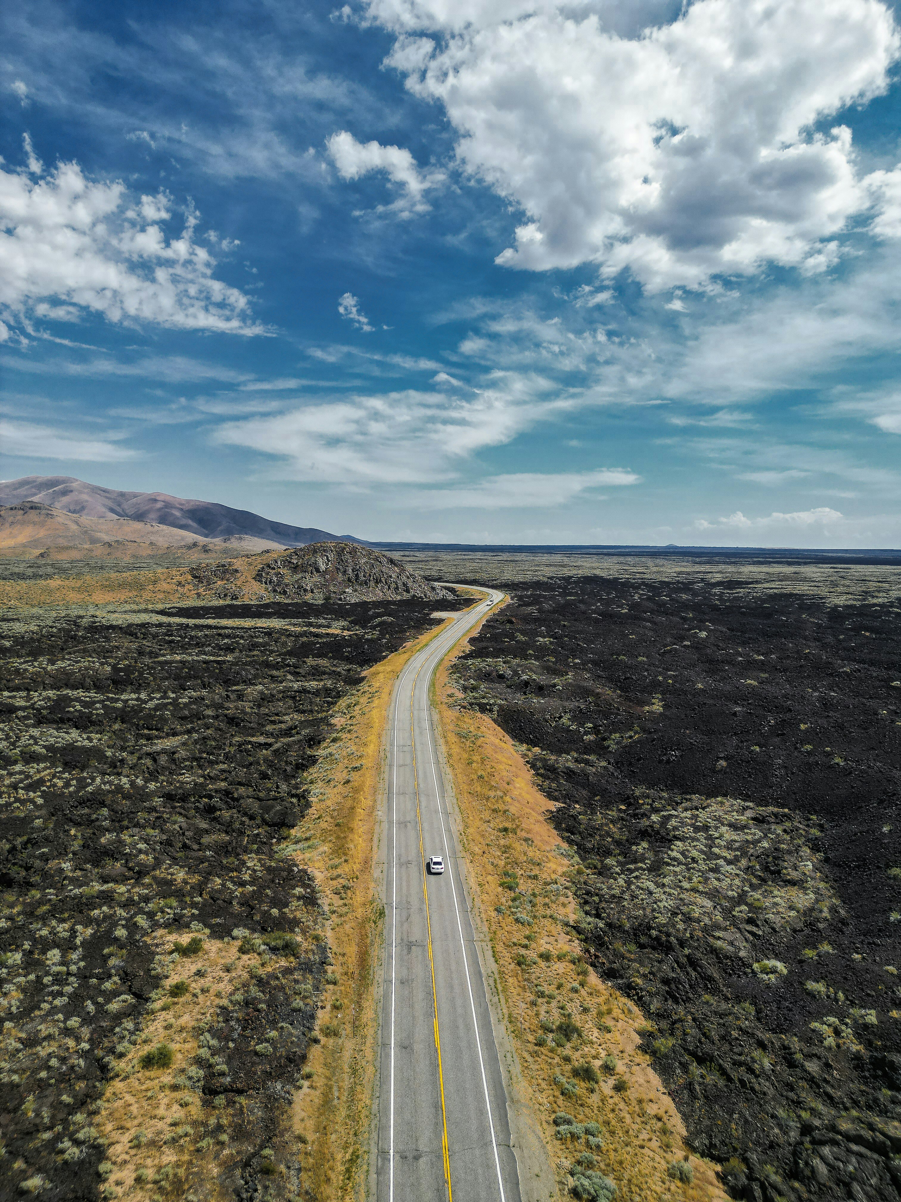 A long straight road with a car on it photo – Free Craters of the moon ...