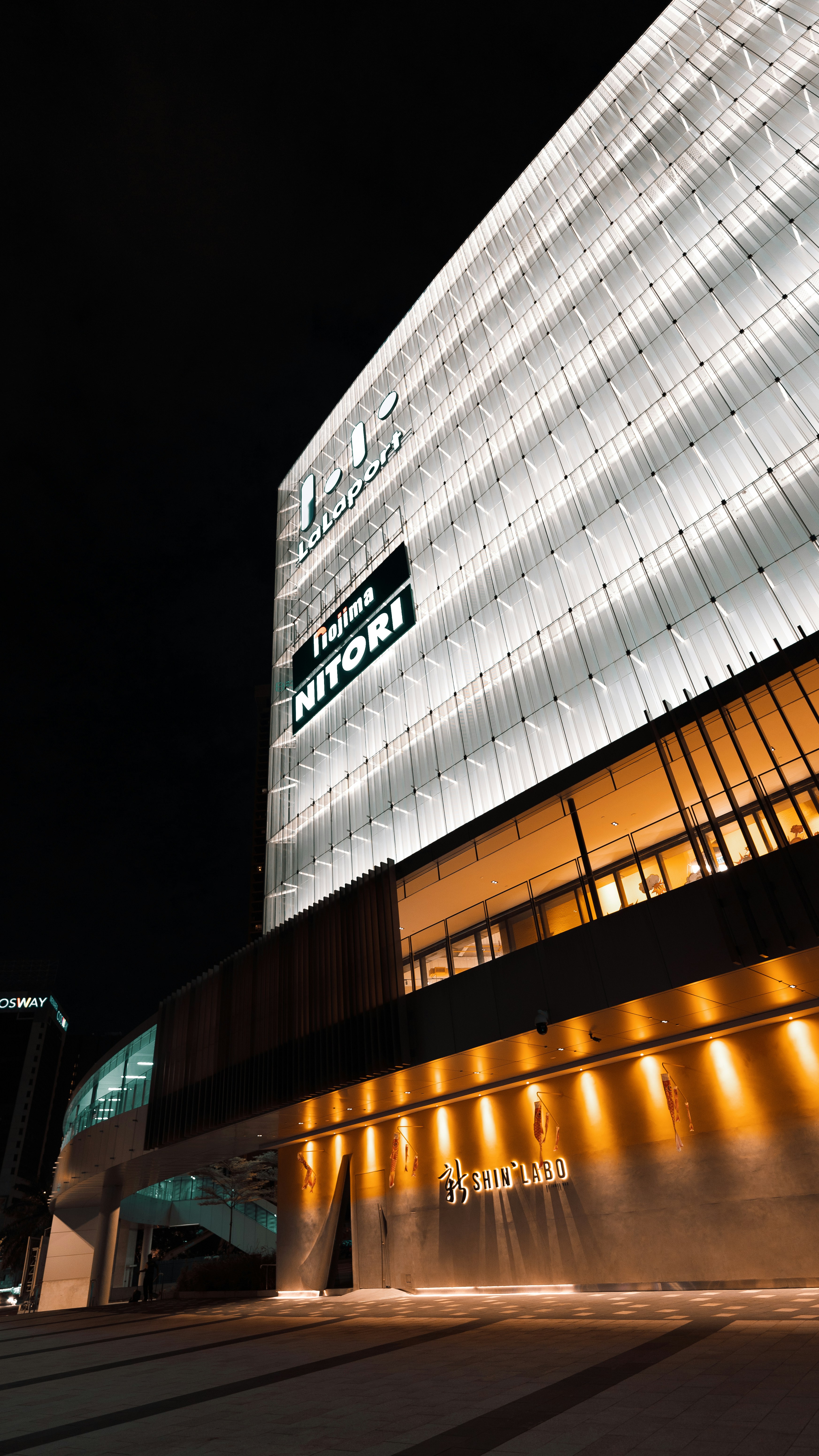 Illuminated facade of Lalaport Bukit Bintang against a dark night sky.