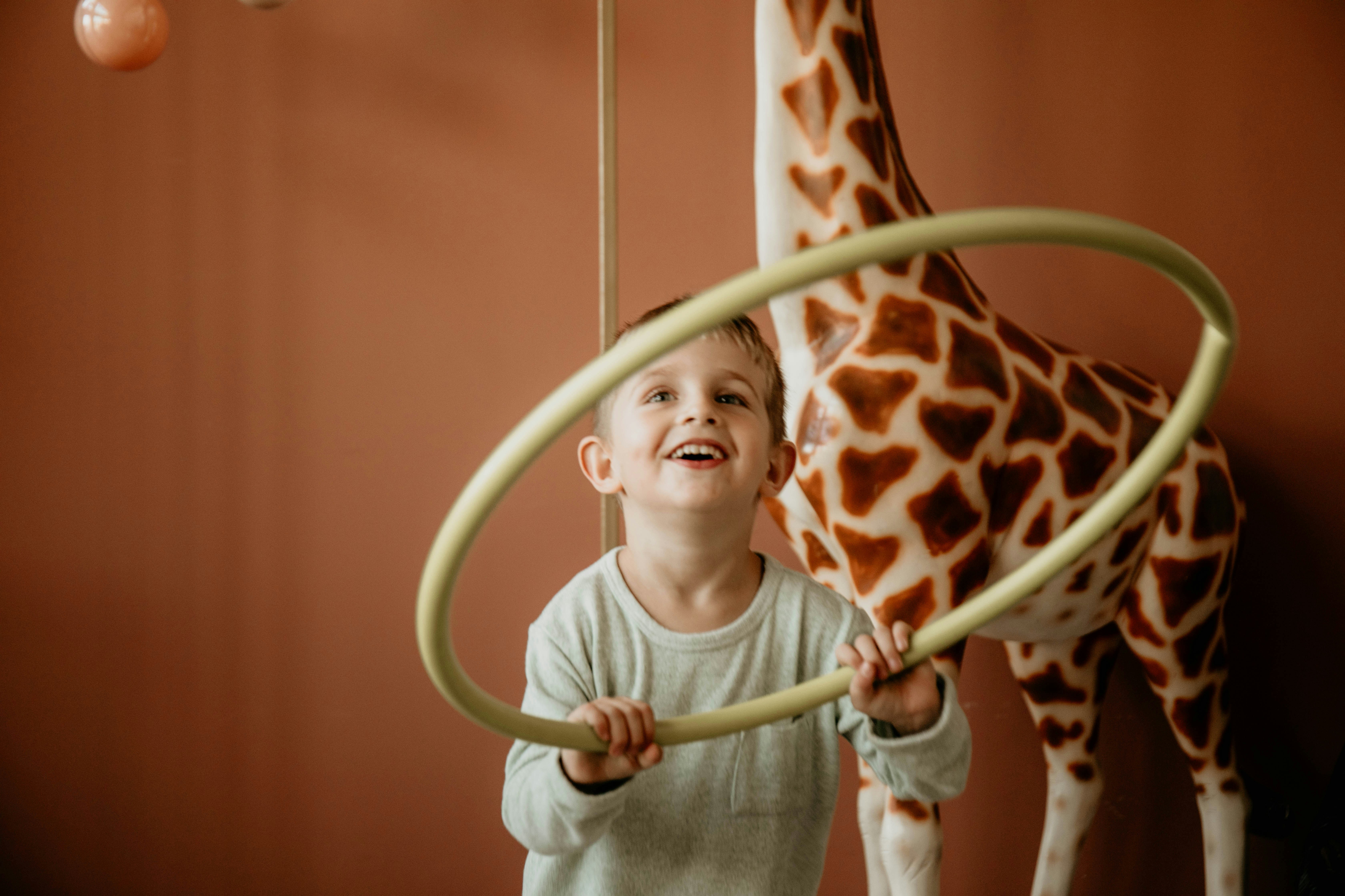 Hoop Dreams: A Playful Portrait with a Giraffe Prop