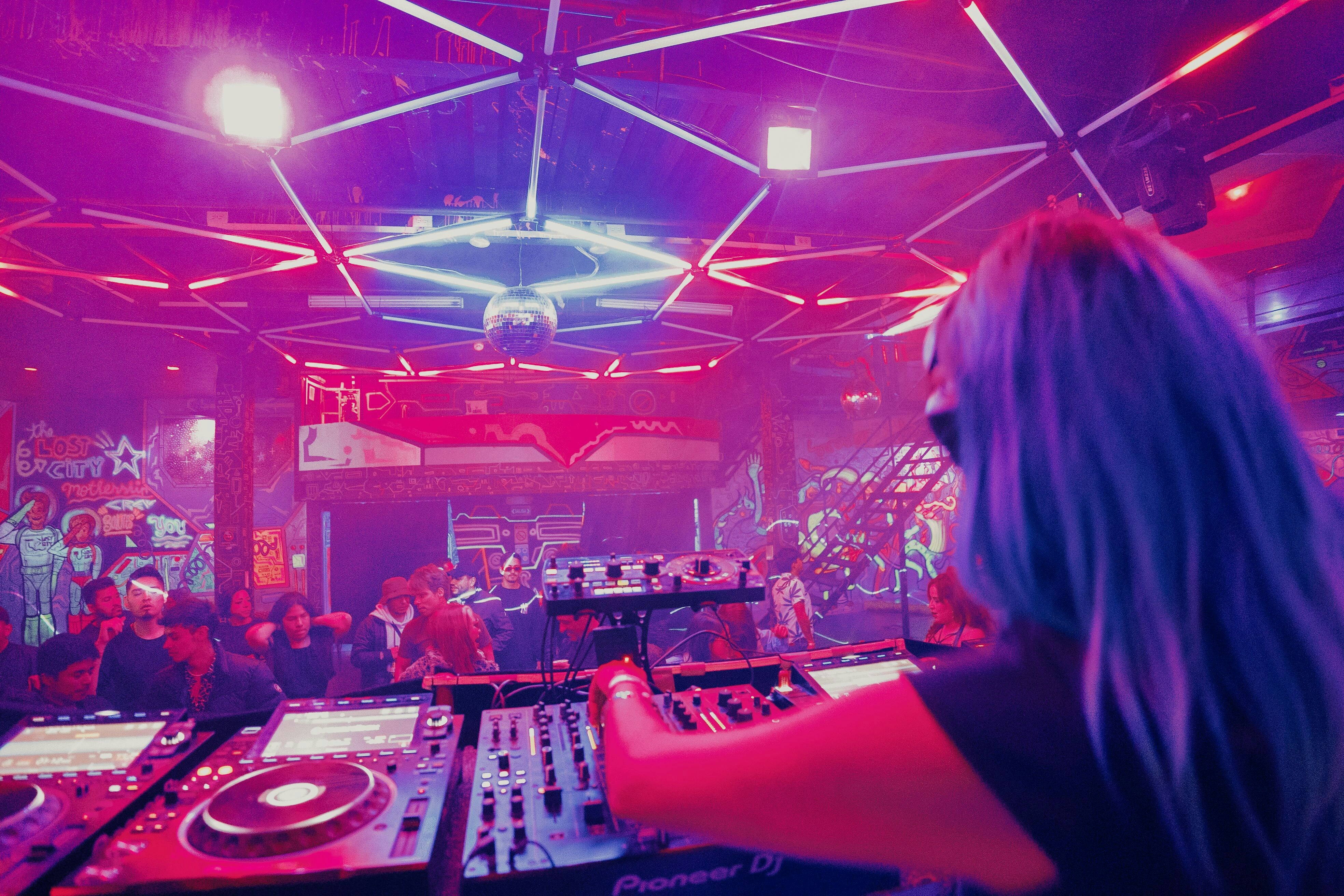 Neon Groove: The DJ’s Console Beneath a Geometric Night