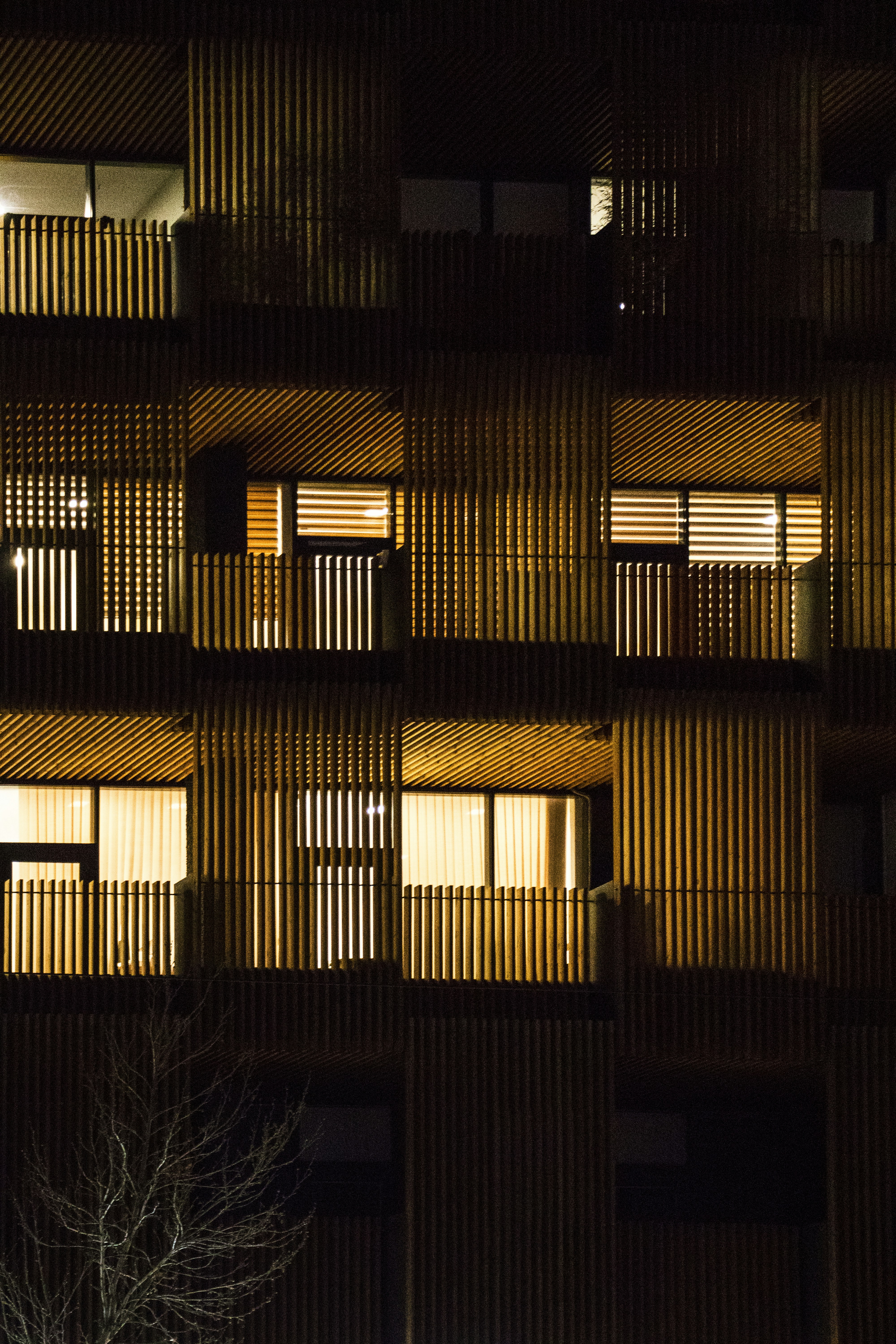 Amber Lattice Nocturne: Warm Windows Behind Vertical Gratings