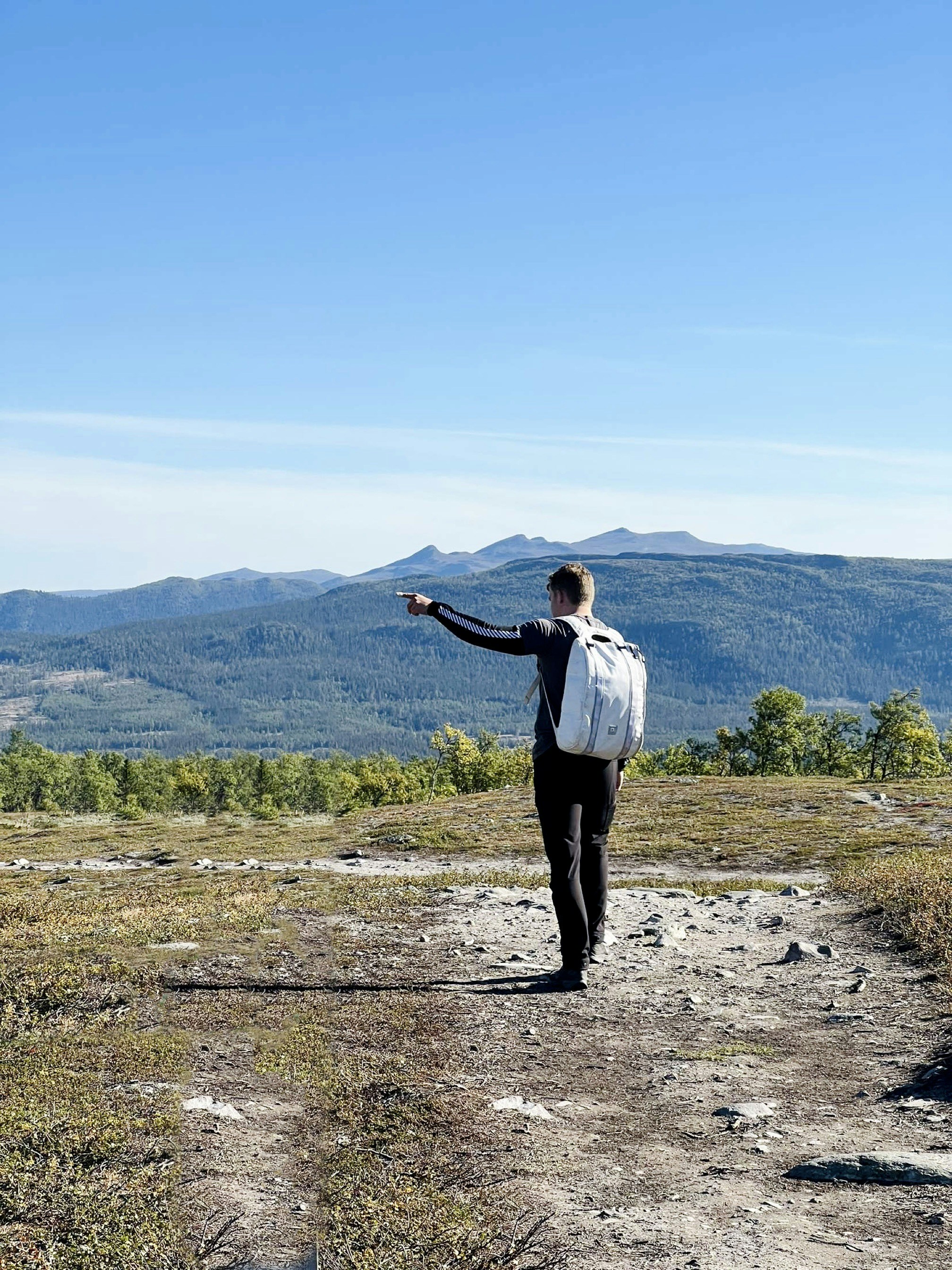 A man standing on a dirt road with his arms raised photo – Free Human ...