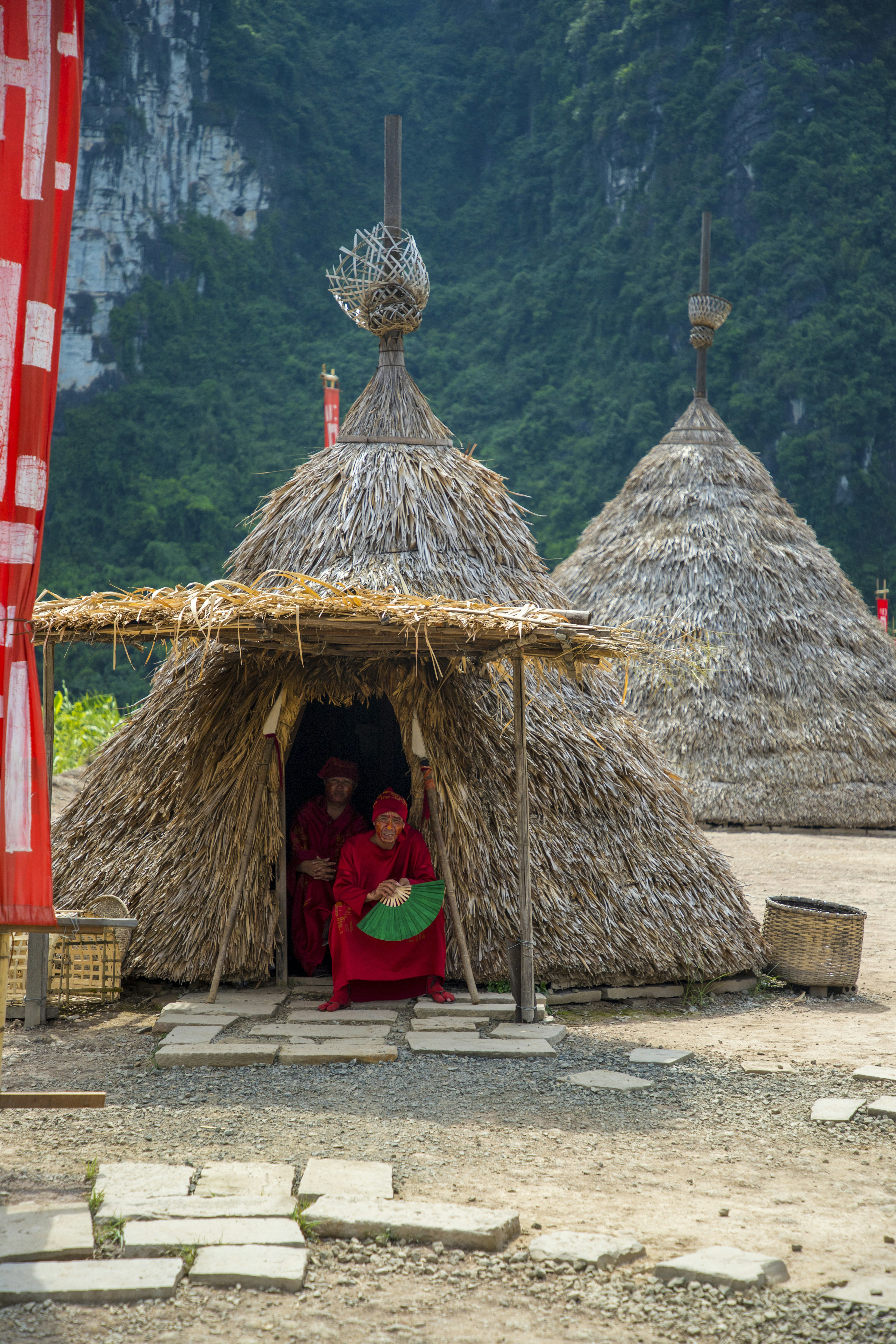 a group of people outside of a hut
