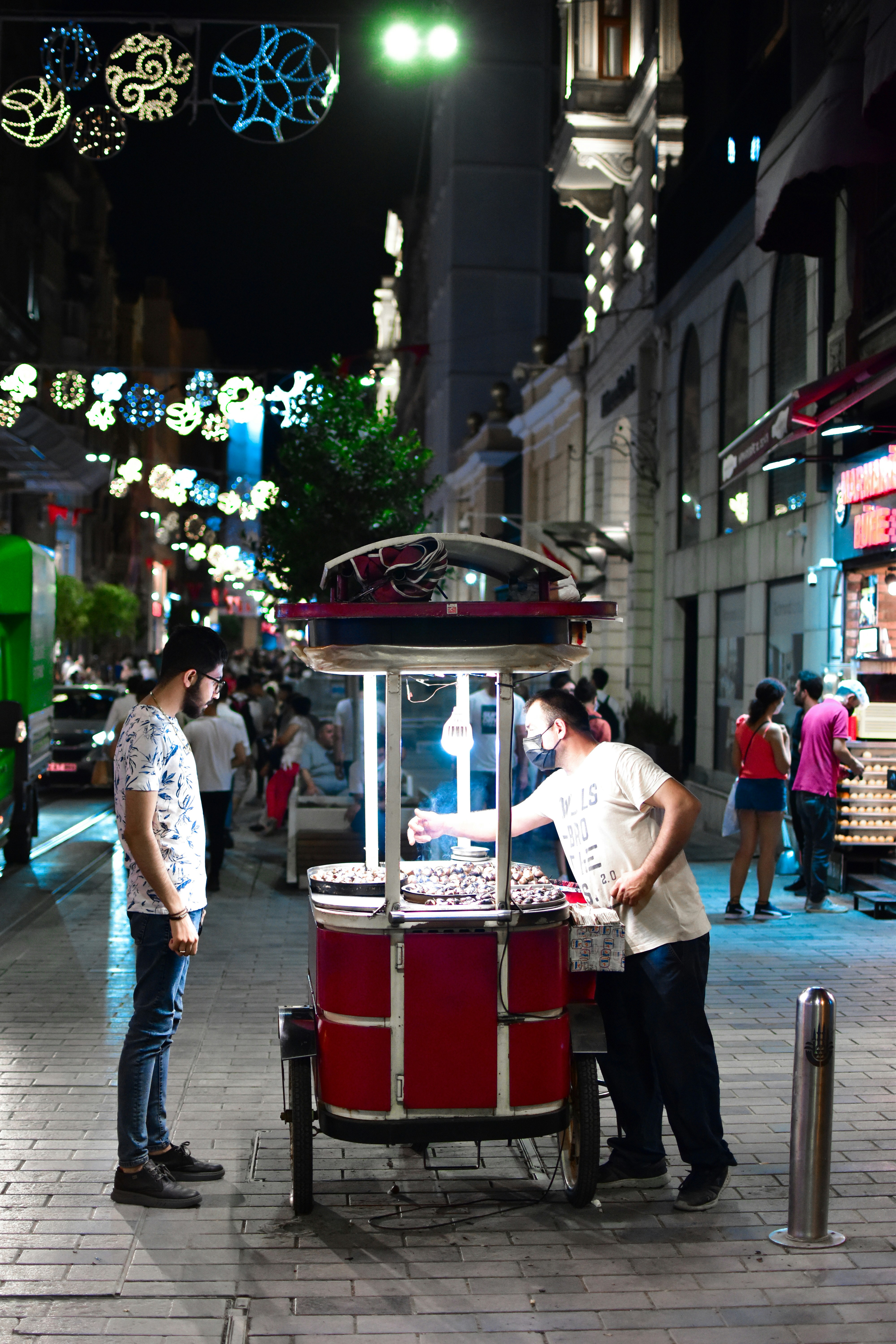 A person selling food on a street photo – Free Night Image on Unsplash