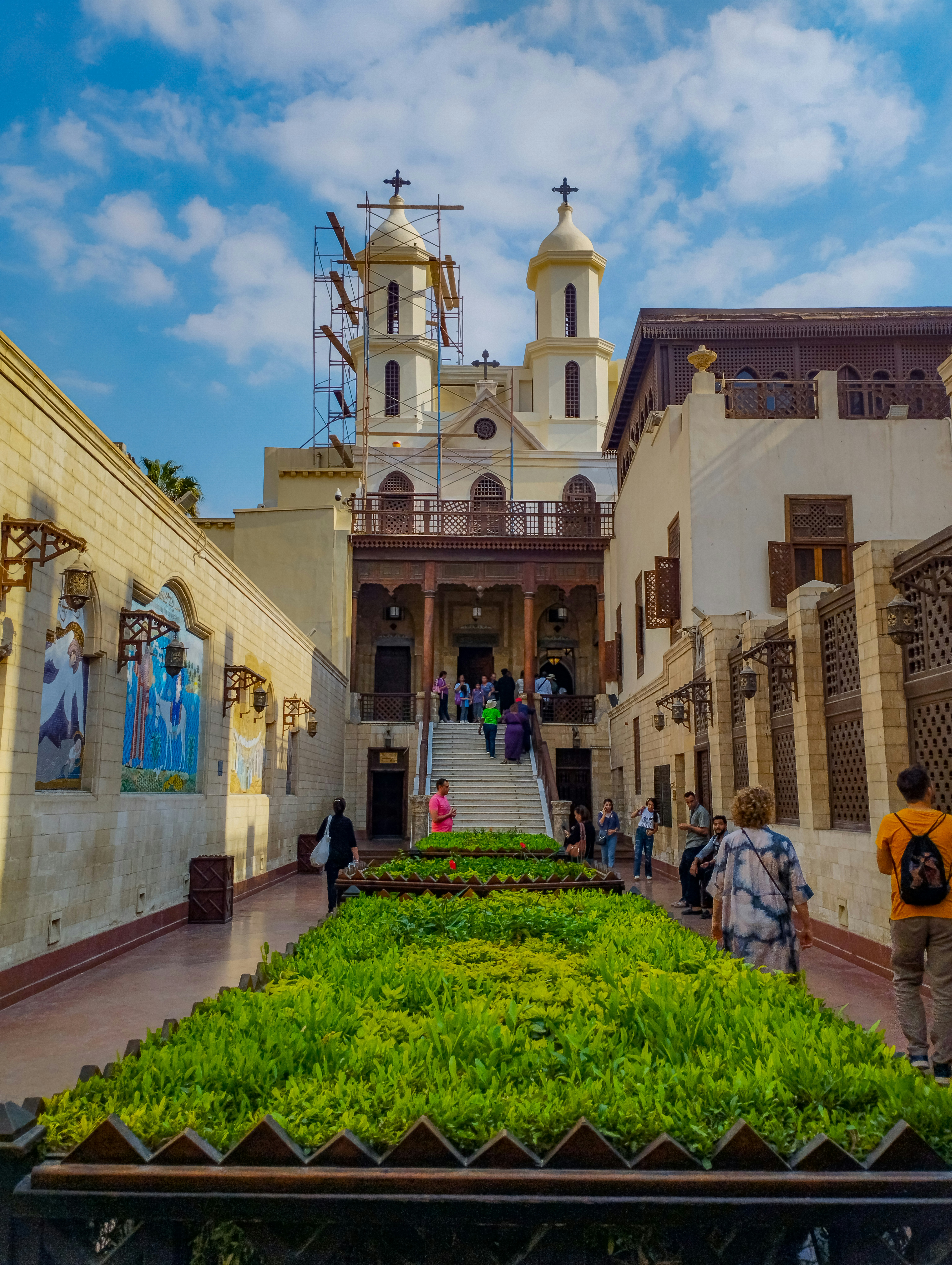 A group of people walking up stairs photo – Free الكنيسة المعلقة Image ...