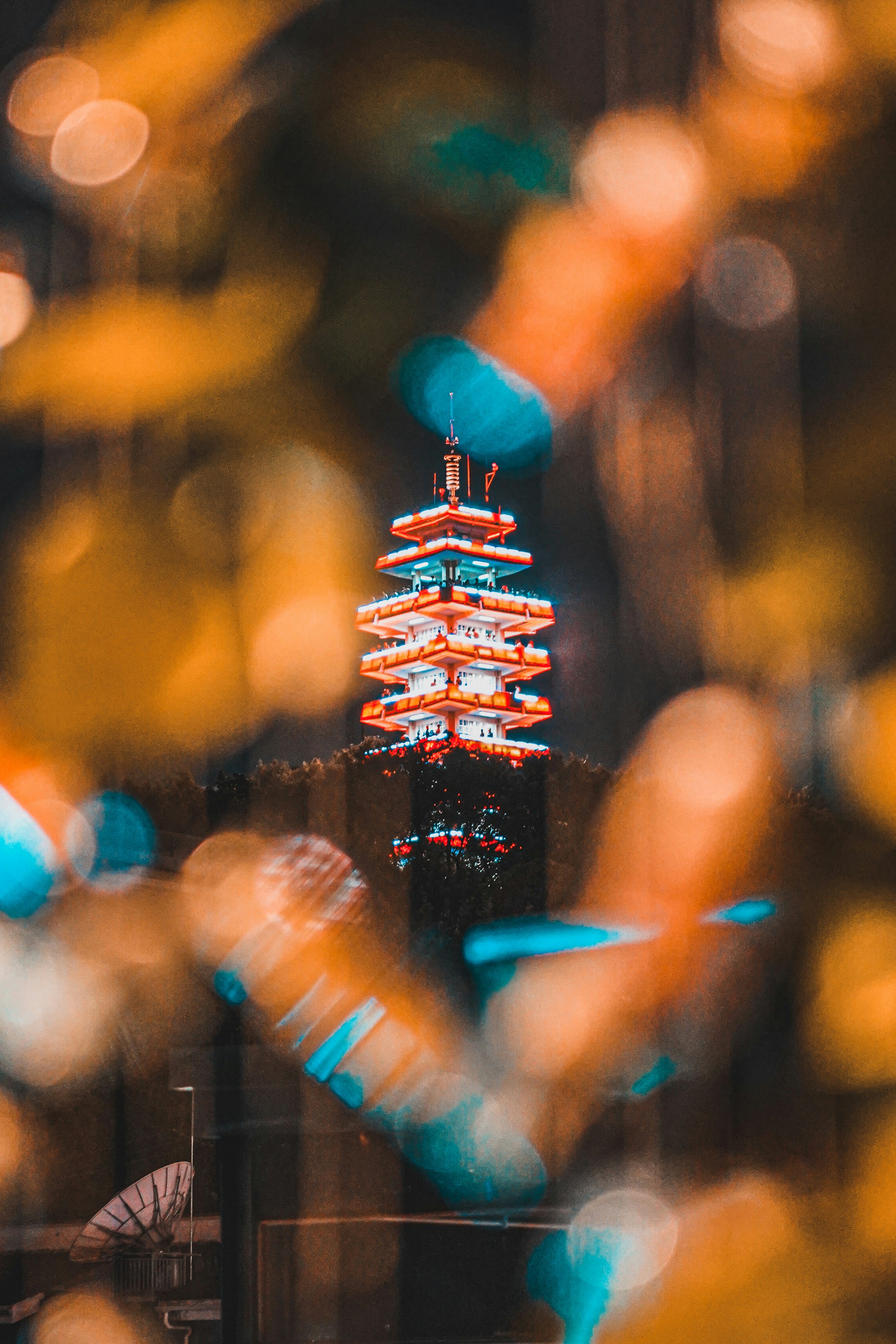 Neon Pagoda: A Nighttime Tower Through a Blur of Bokeh