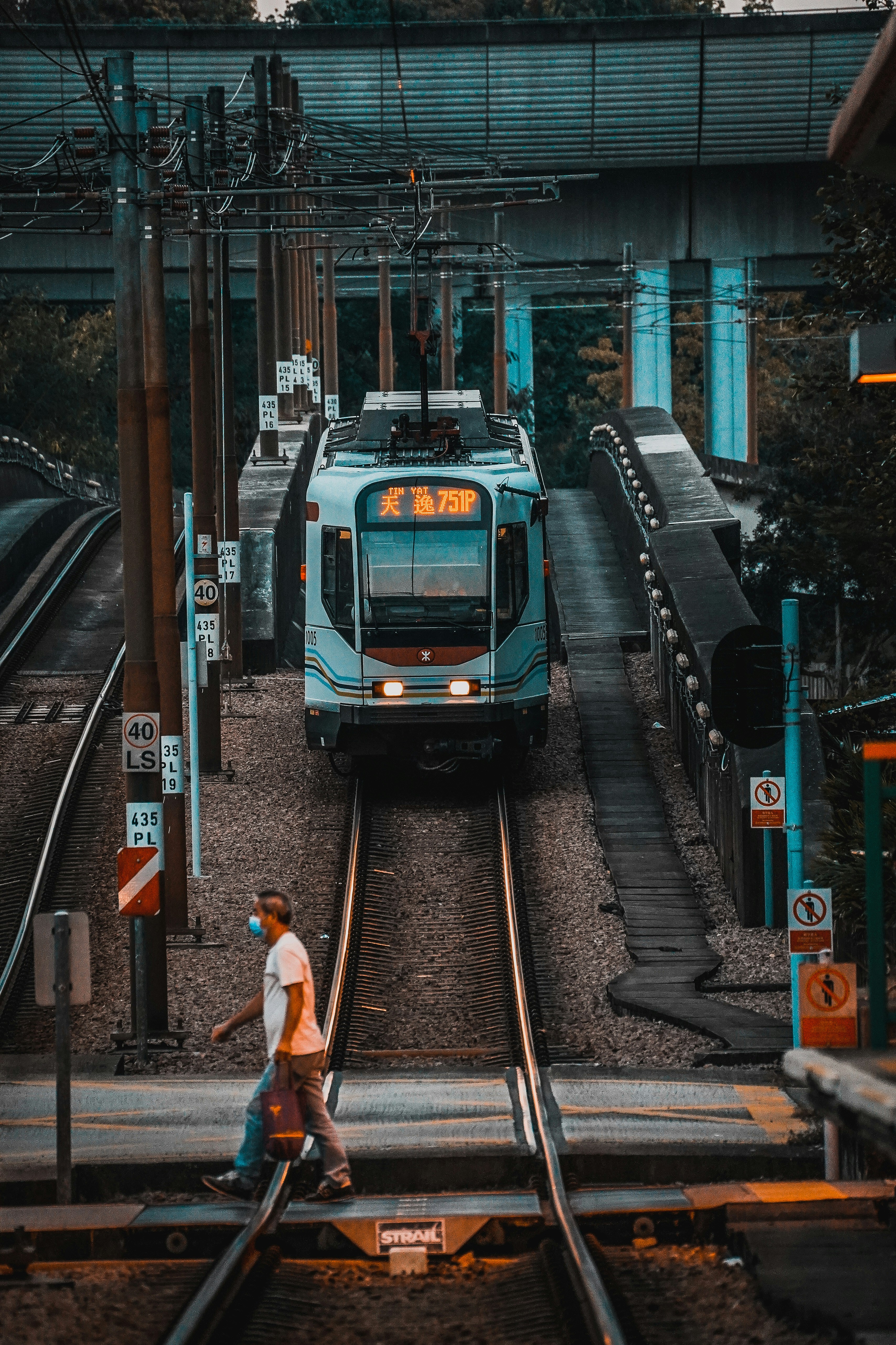 A person walking on a train track photo – Free Kowloon Image on Unsplash