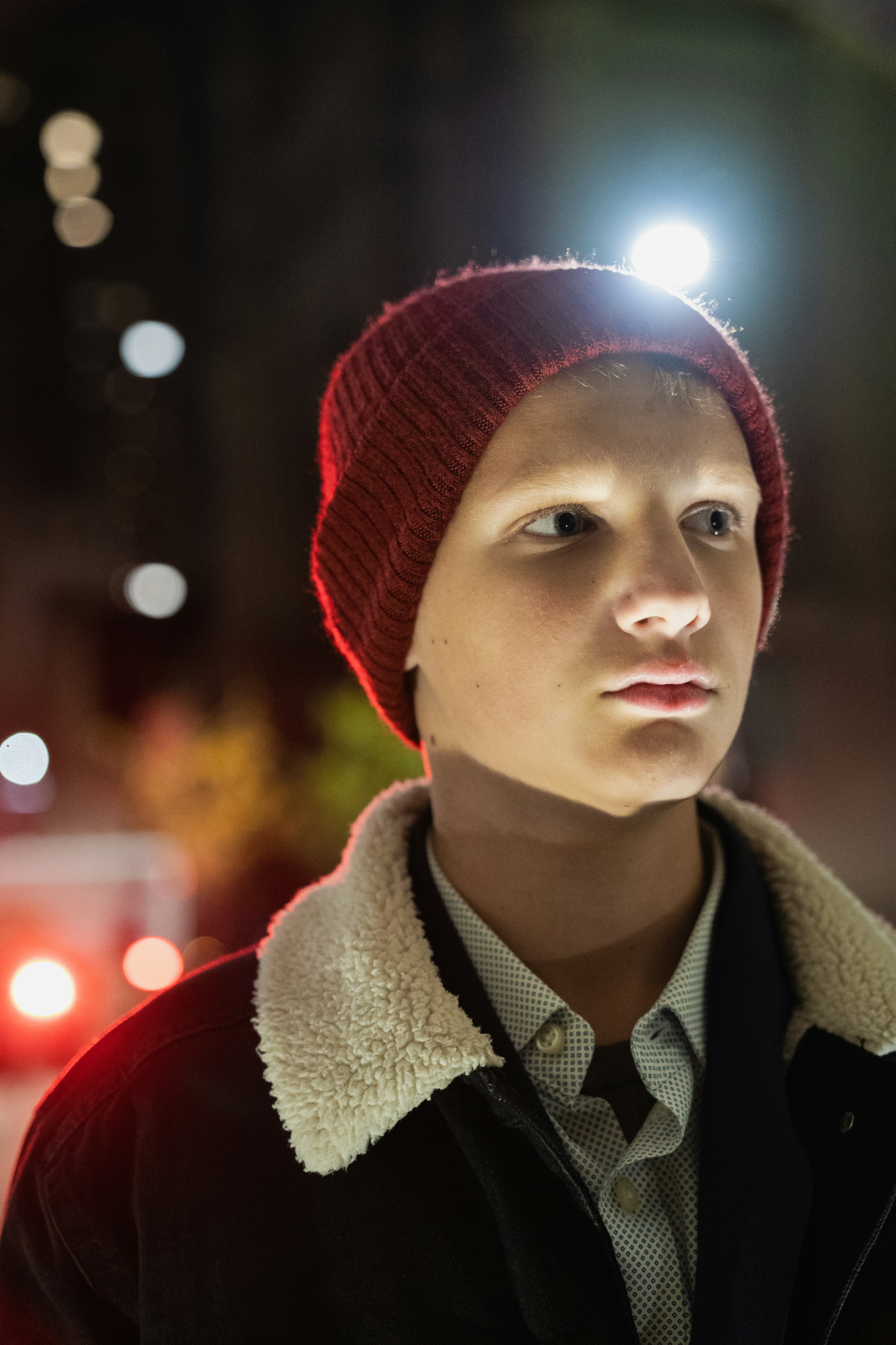 Neon Night Gaze: Portrait of a Young Man in a Red Beanie