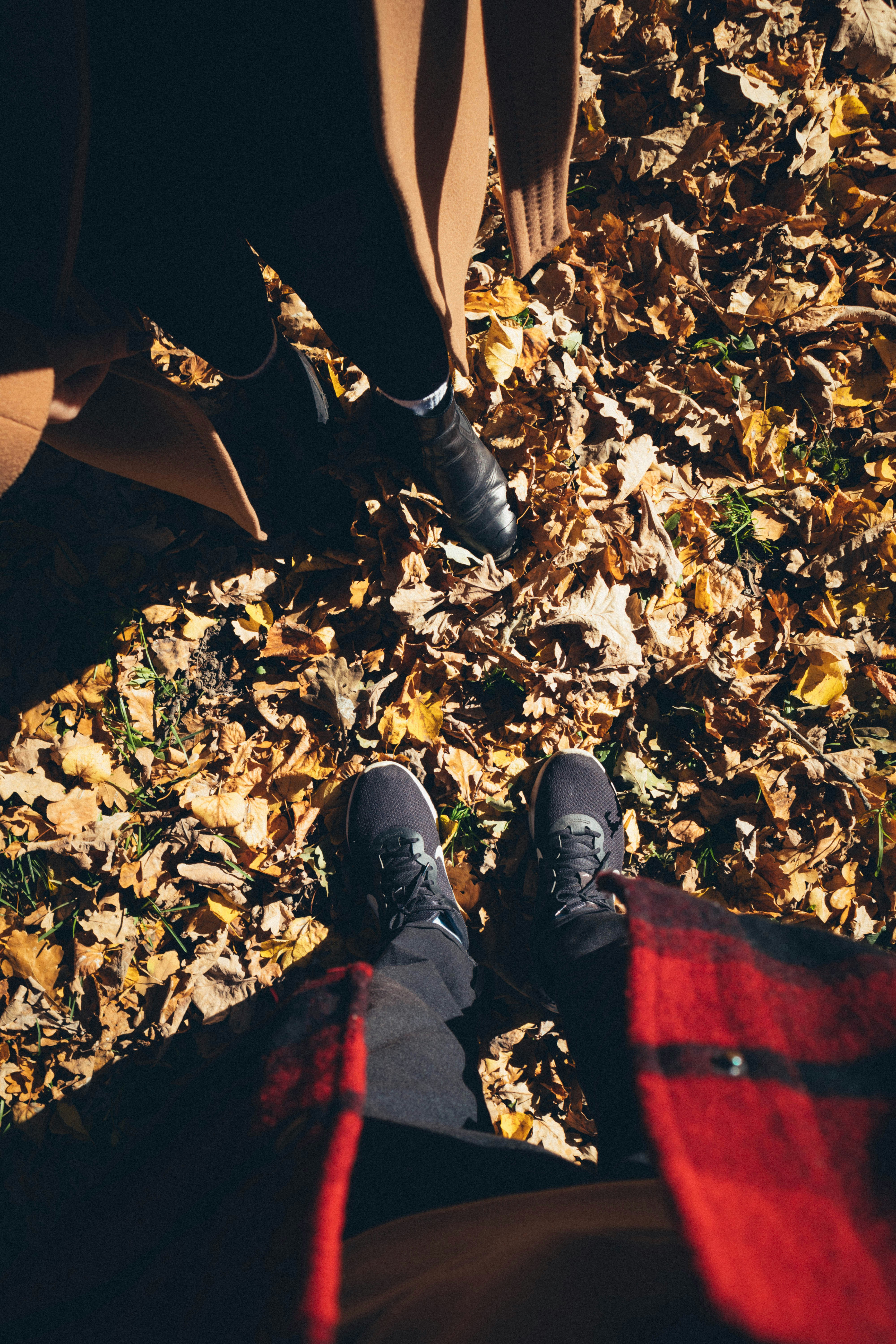 Amber Grounding: Boots Amid a Carpet of Fall Leaves