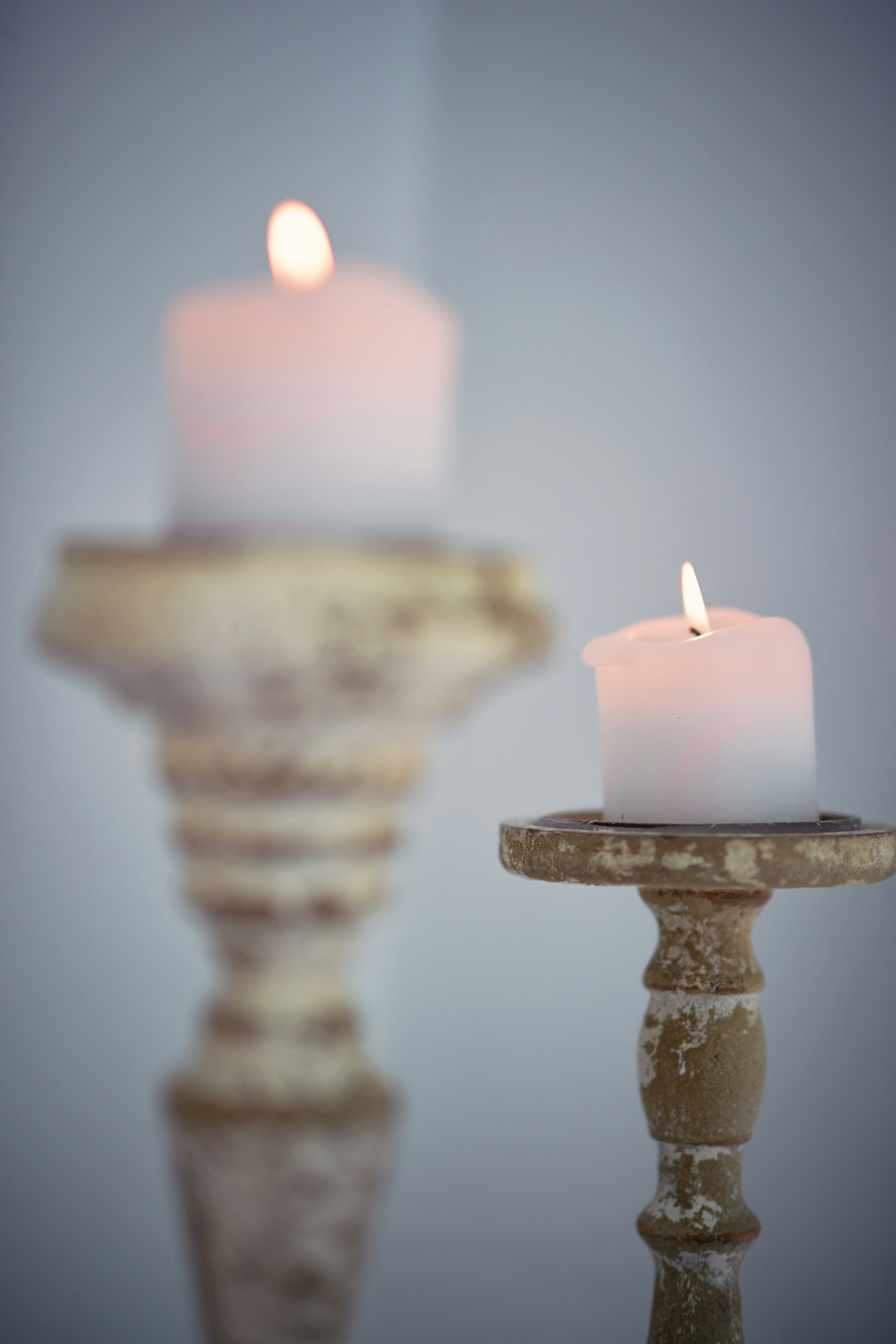 Whispers of Light: Twin Flames on Rustic Stands