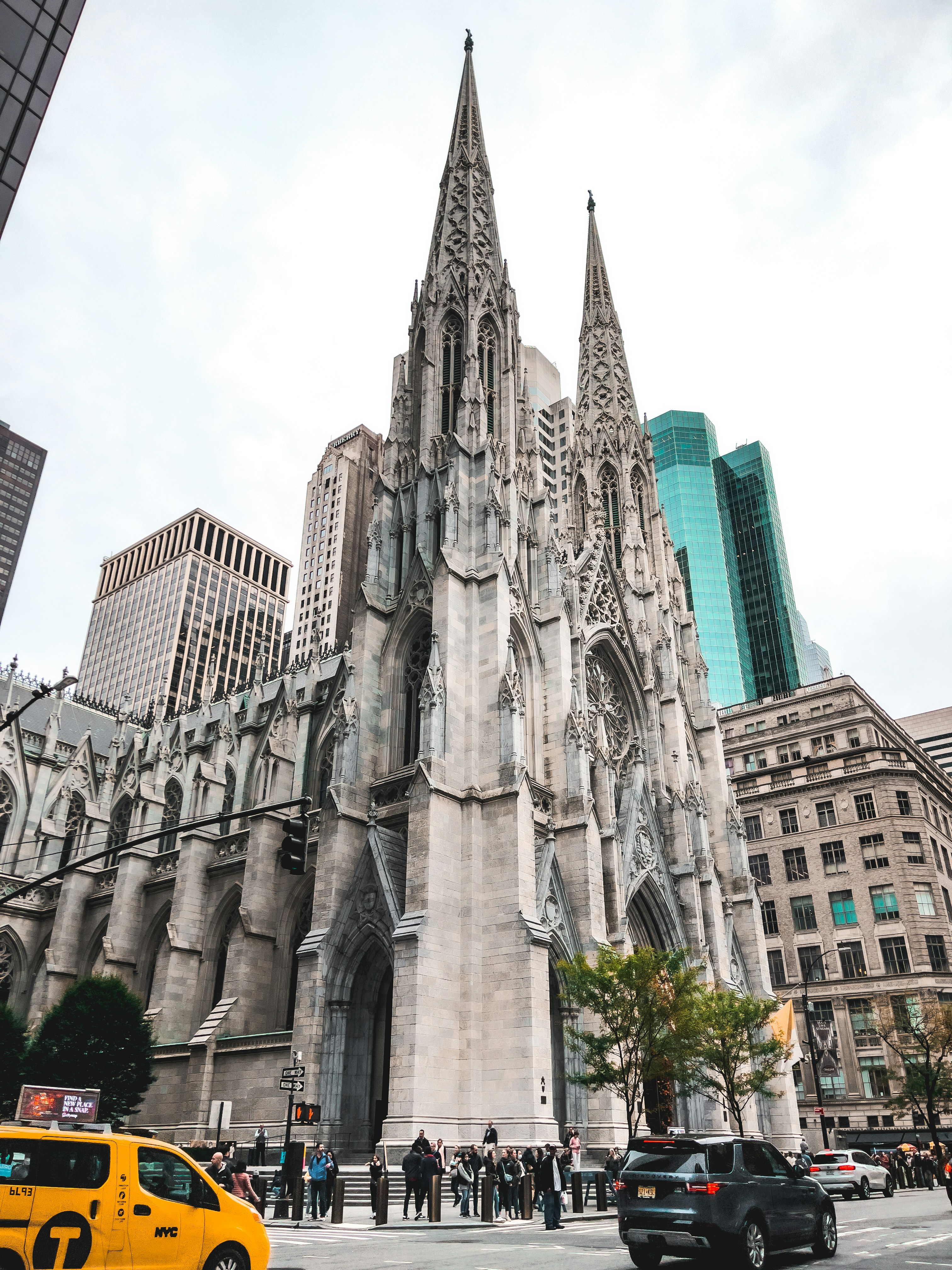 A large stone building with a tall spire photo – Free New york Image on ...