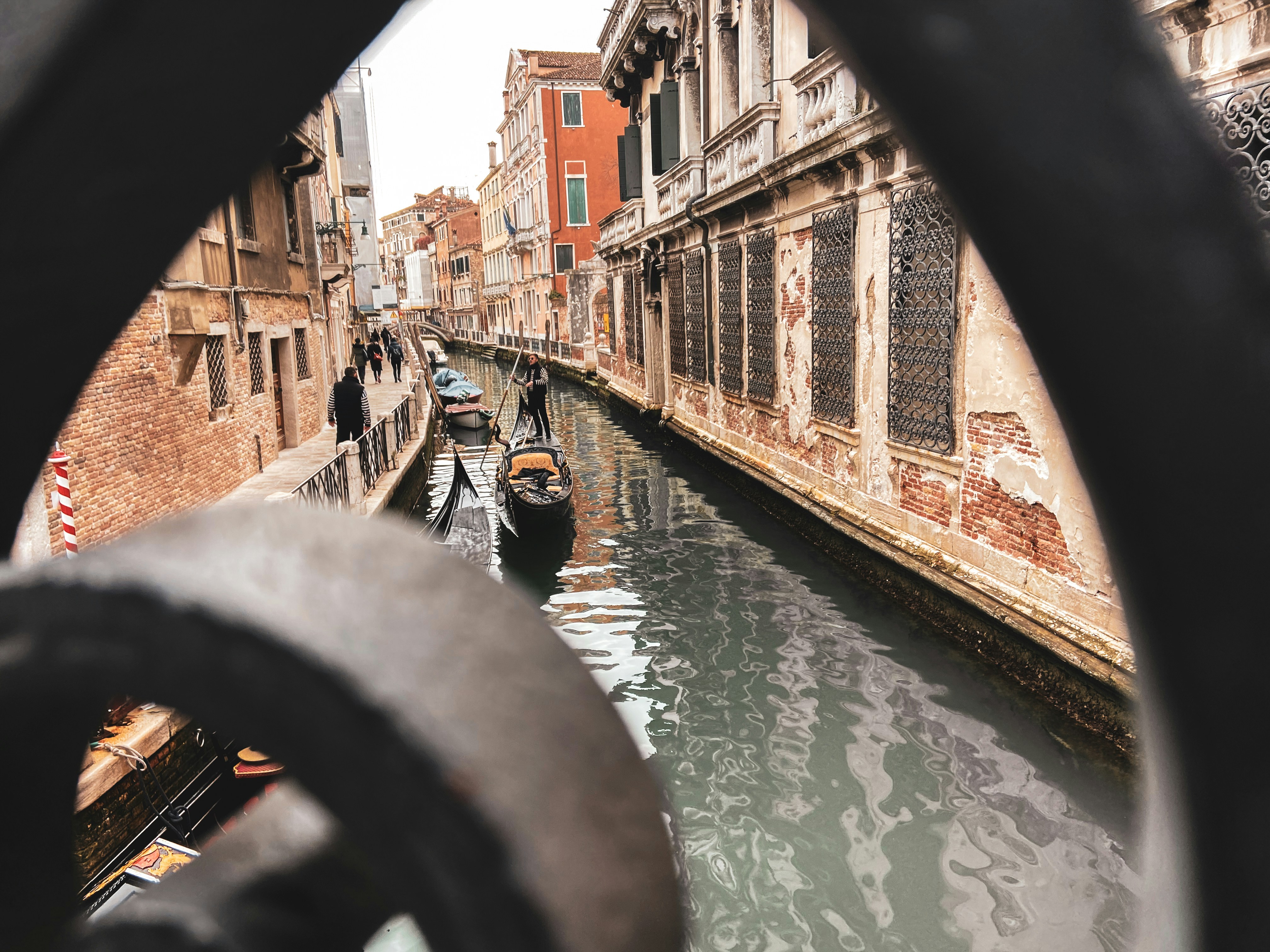 Through the Ring to Venice: A Narrow Canal Framed by Brick Palazzos