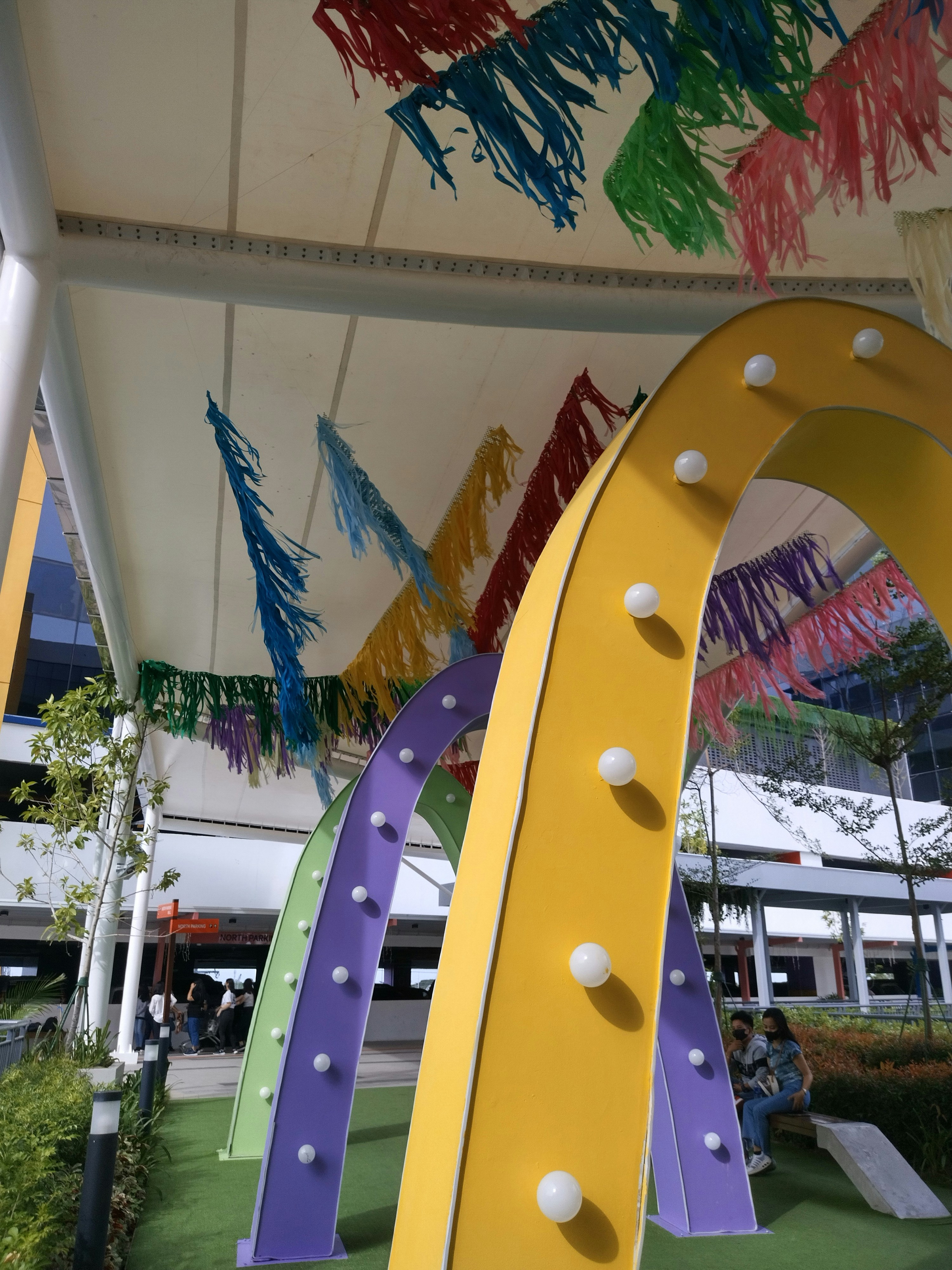 Archway Parade: Bulb-Studded Arches Under a Festive Canopy
