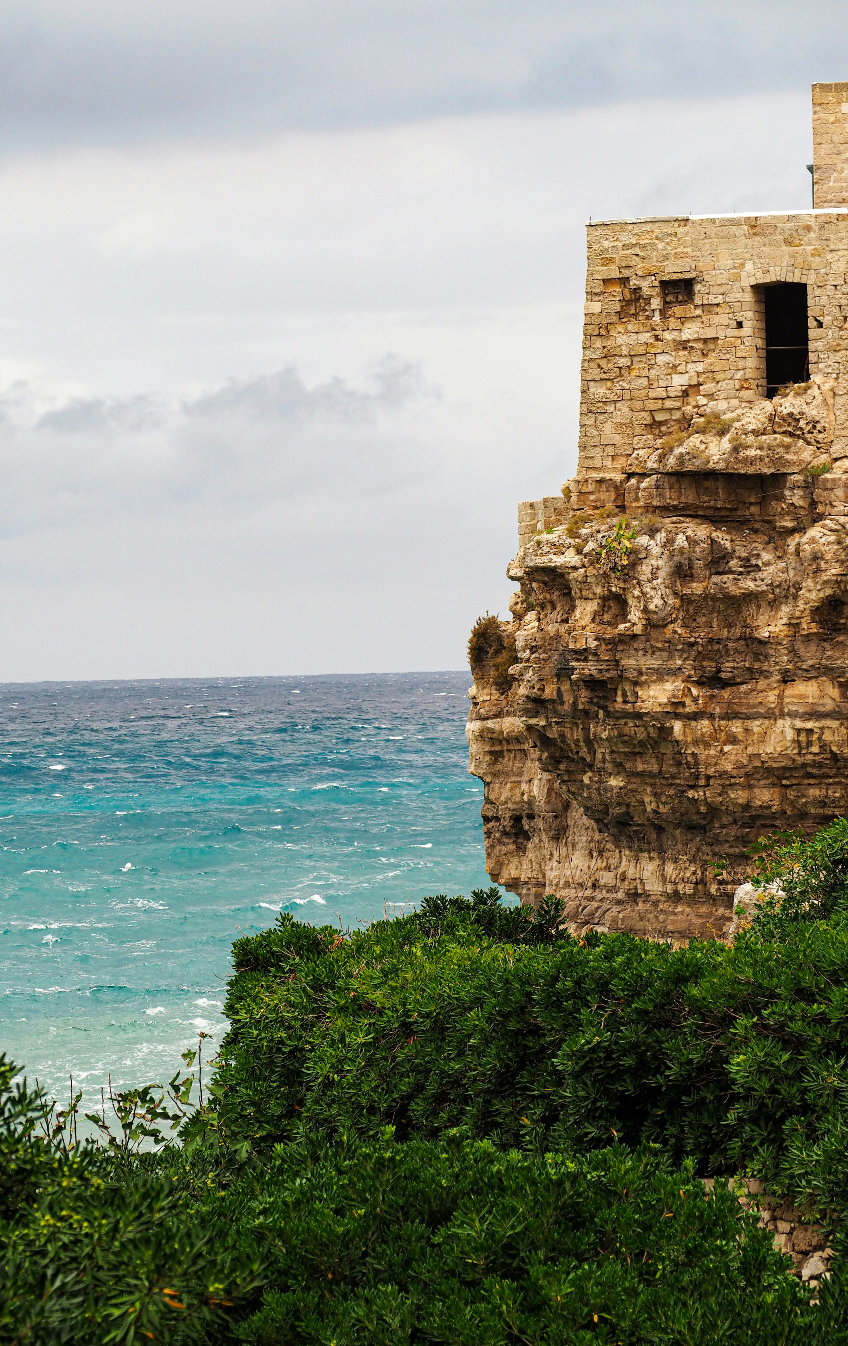 Sea-Cliff Outpost: Stone Structure Crowned by Ocean