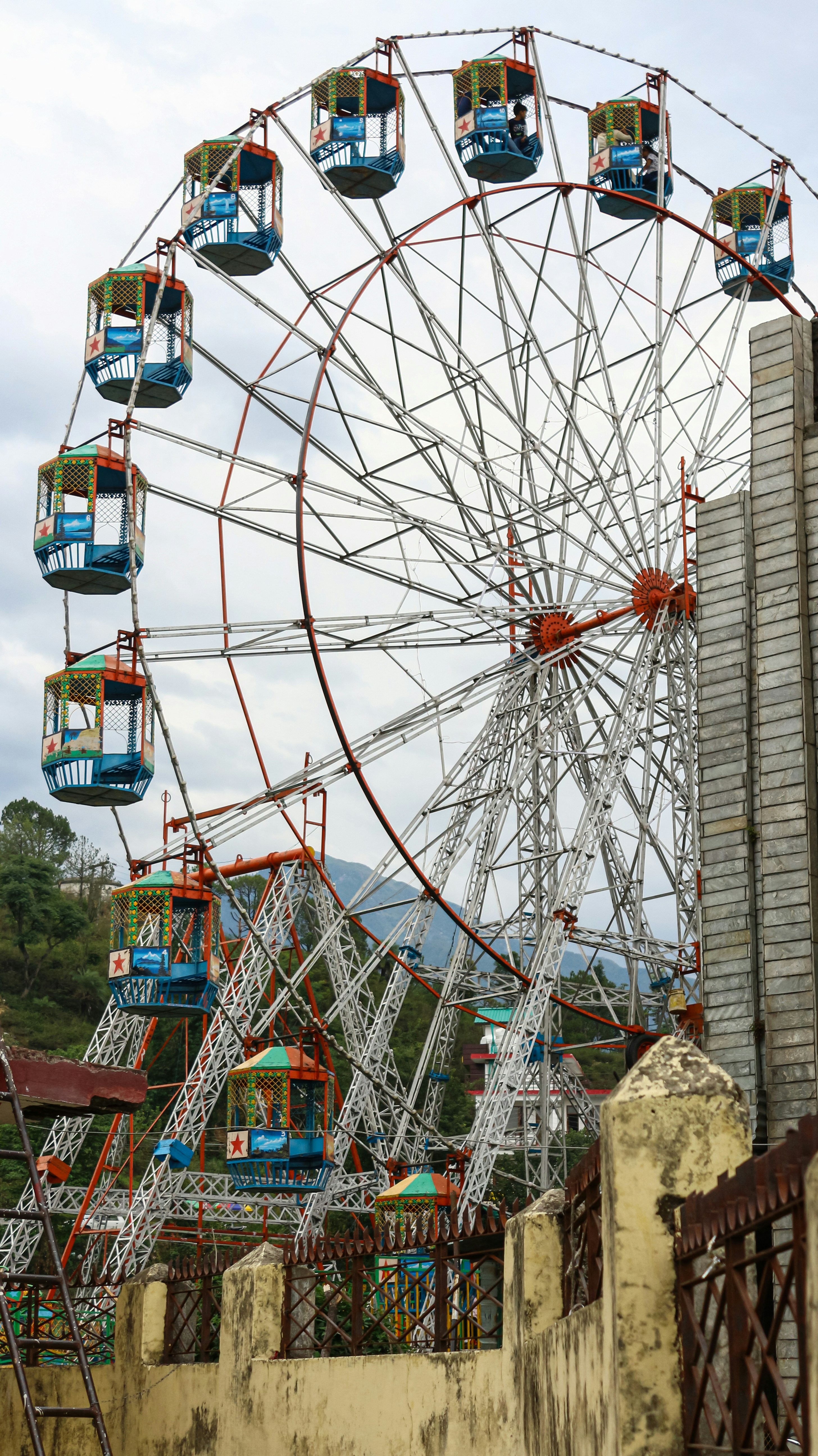 a large ferris wheel sitting next to a tall building