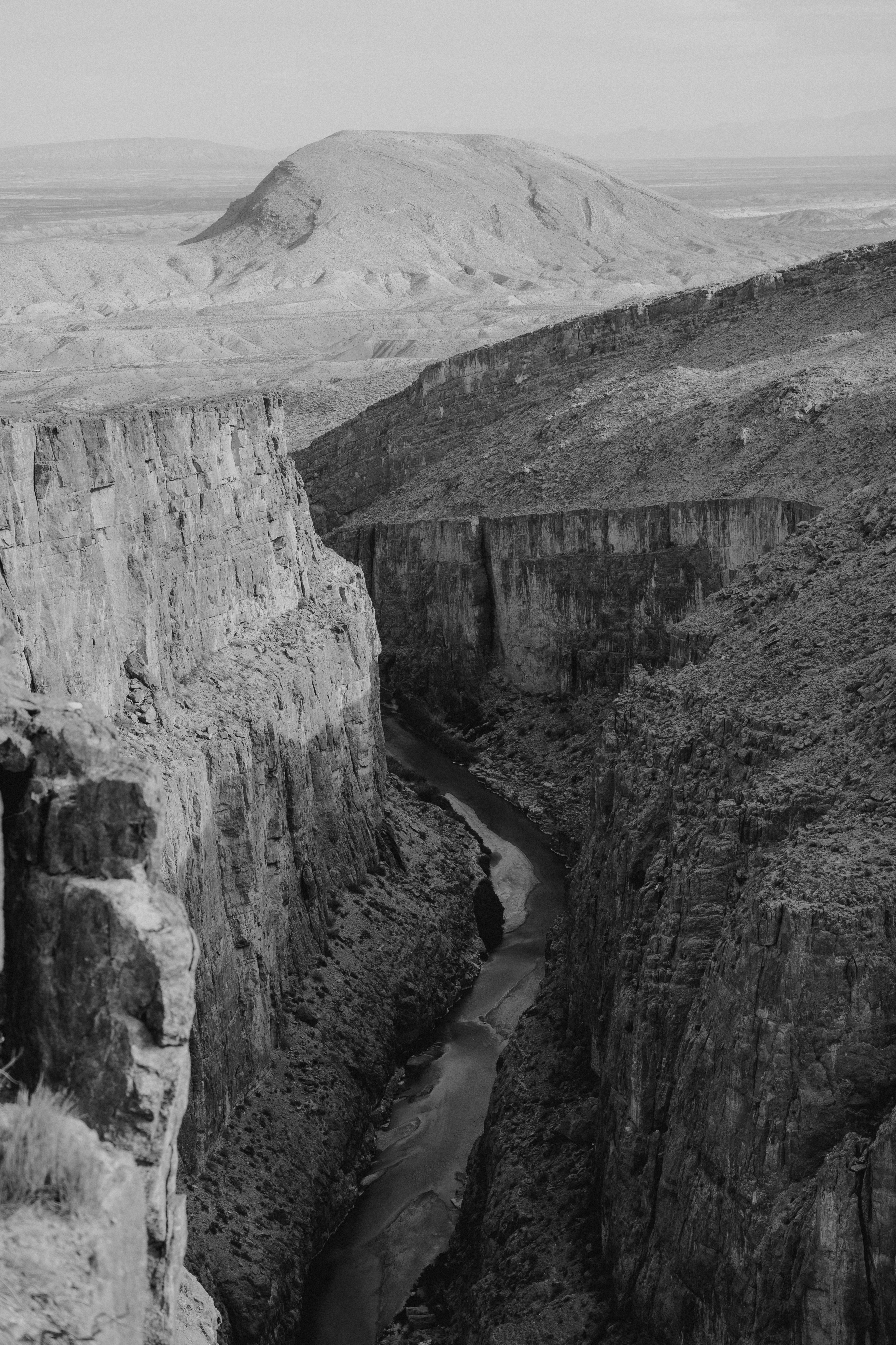 Monochrome Gorge: The River's Quiet Vein Winding Through Stark Cliffs