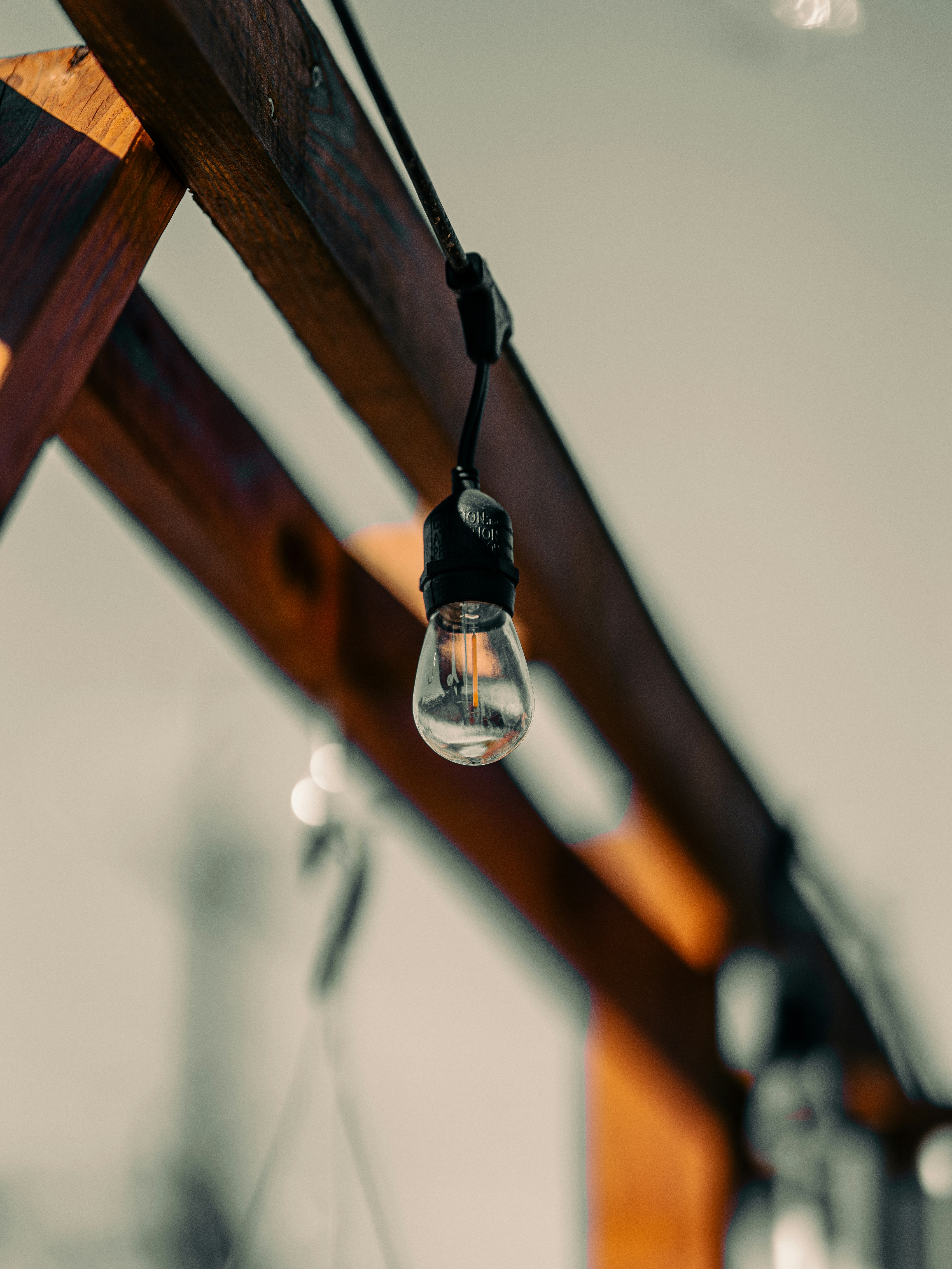 Hanging Edison Glow Between Weathered Beams
