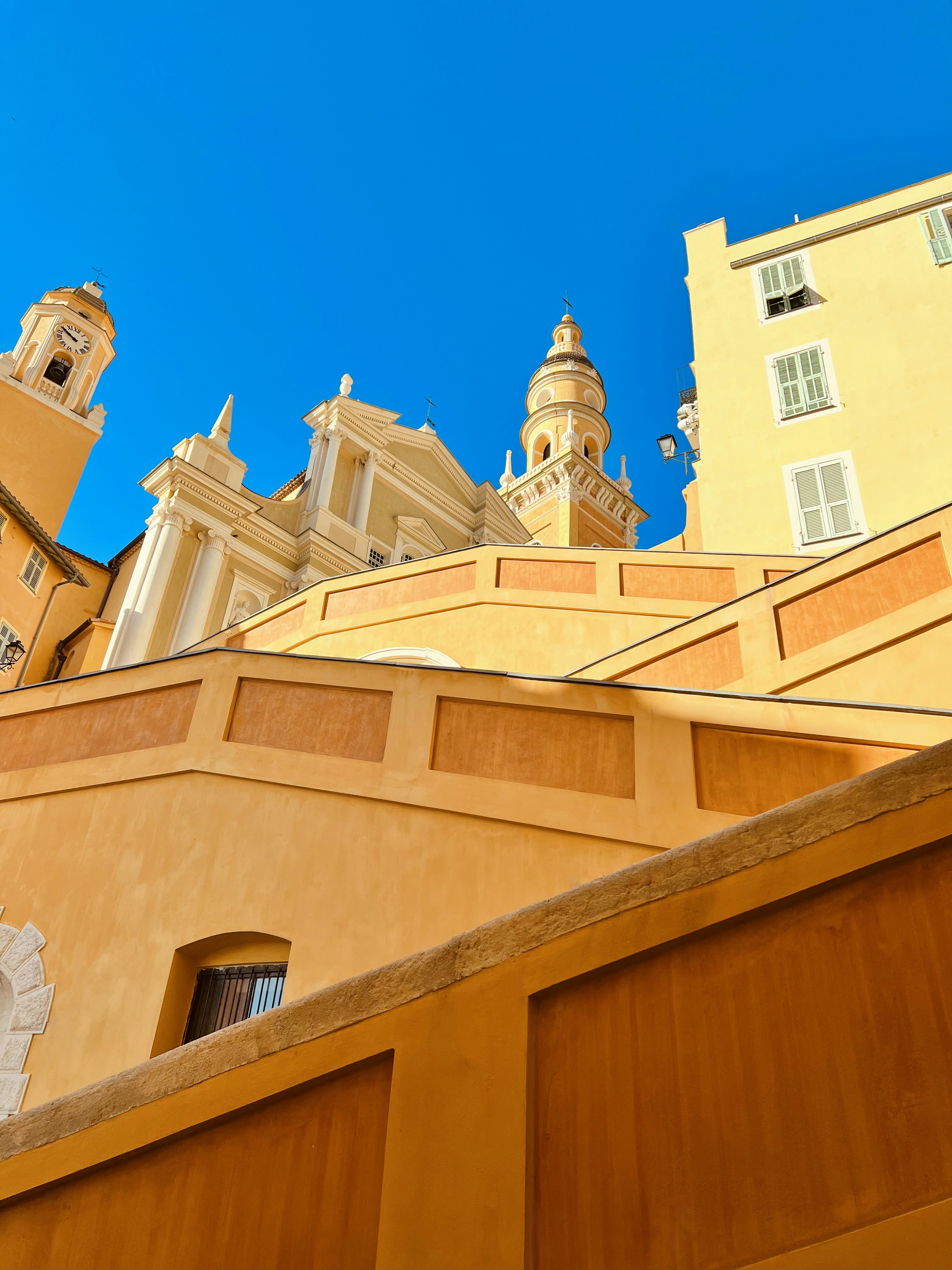 Low-Angle Luminosity: Sunlit Yellow Facades and White Baroque Towers Against a Cerulean Sky