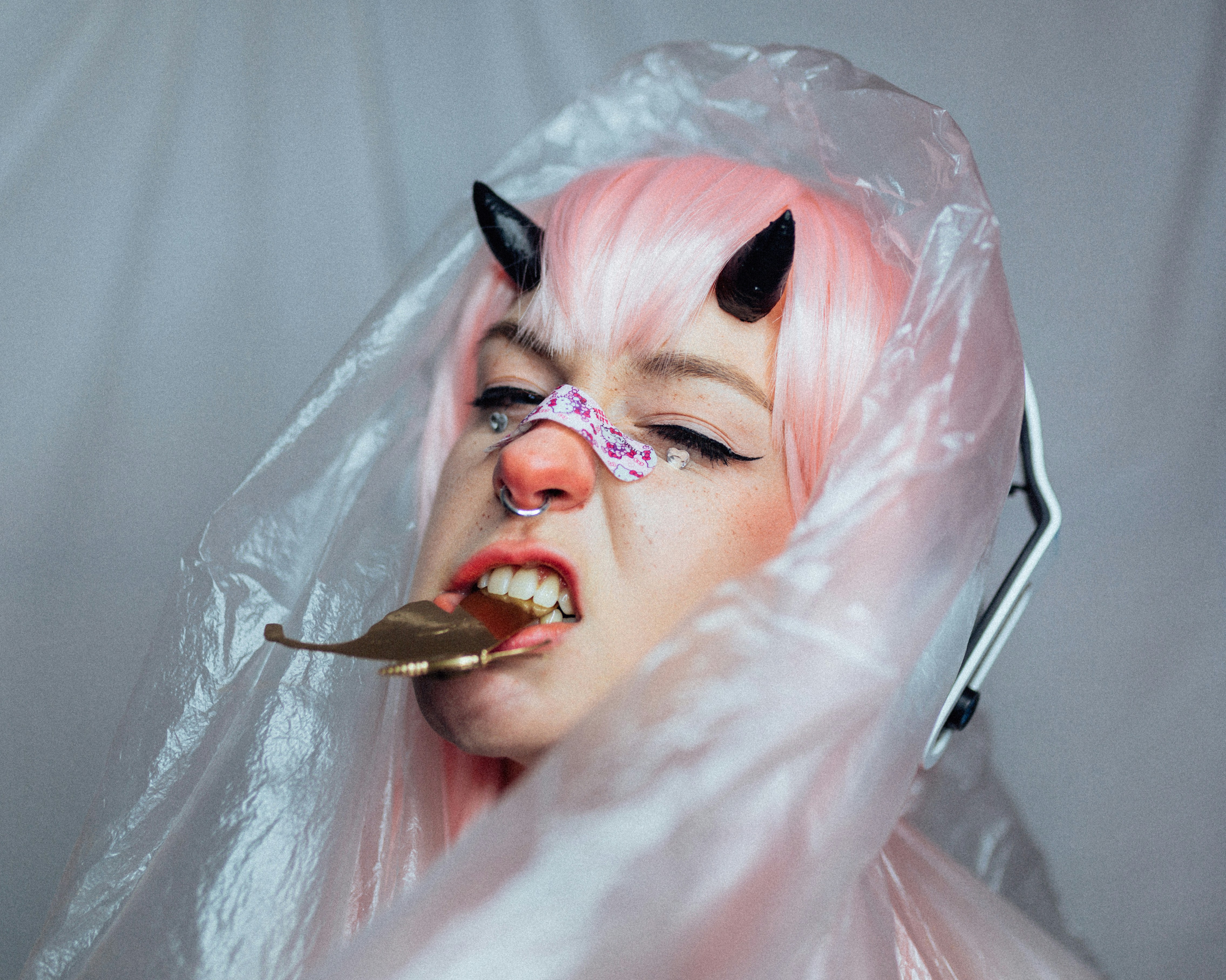 Pastel Demon Portrait: Close-Up of Horns, Leaf, and Plastic Veil