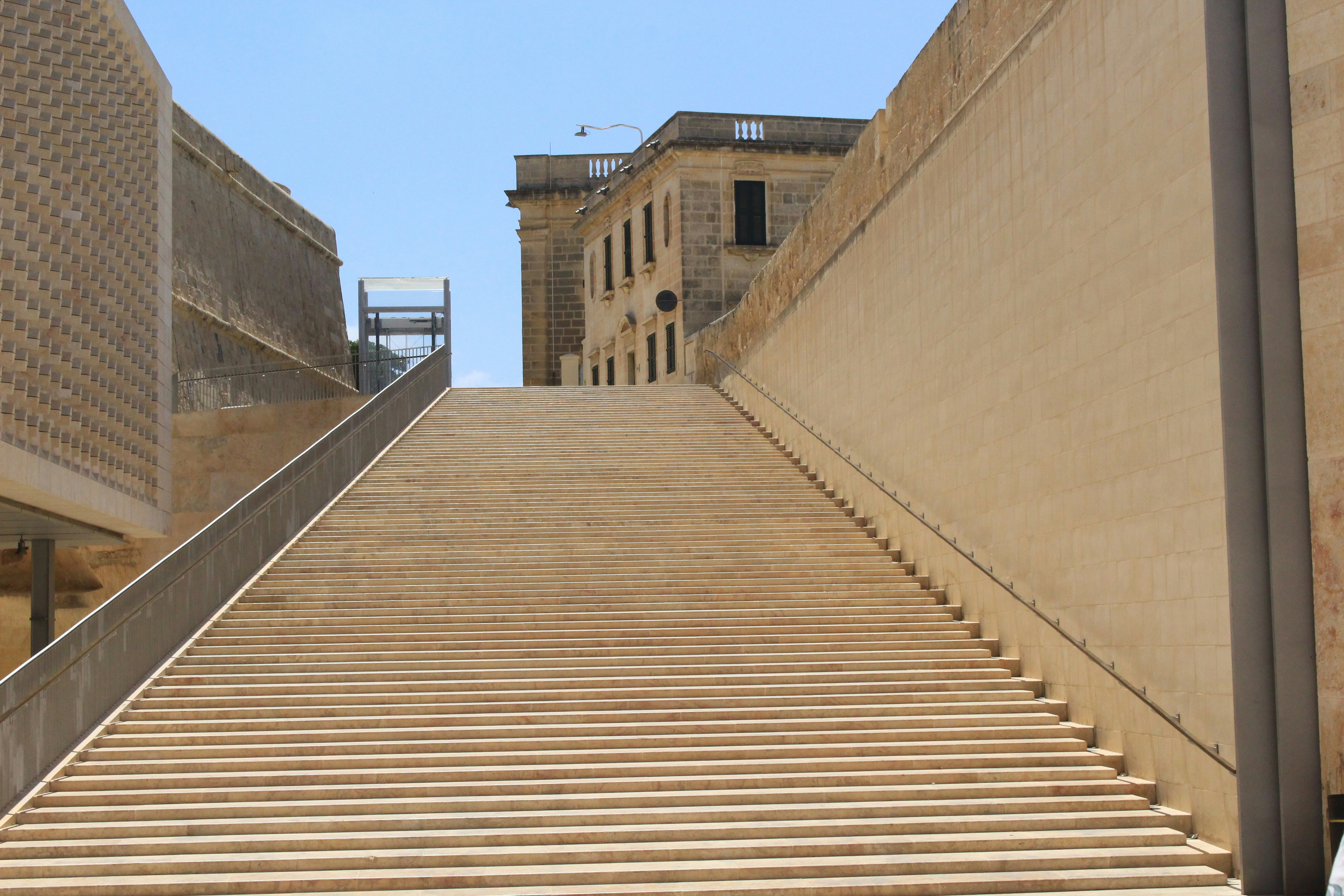 Ascending Light: A Stairway Framing a Sunlit Facade