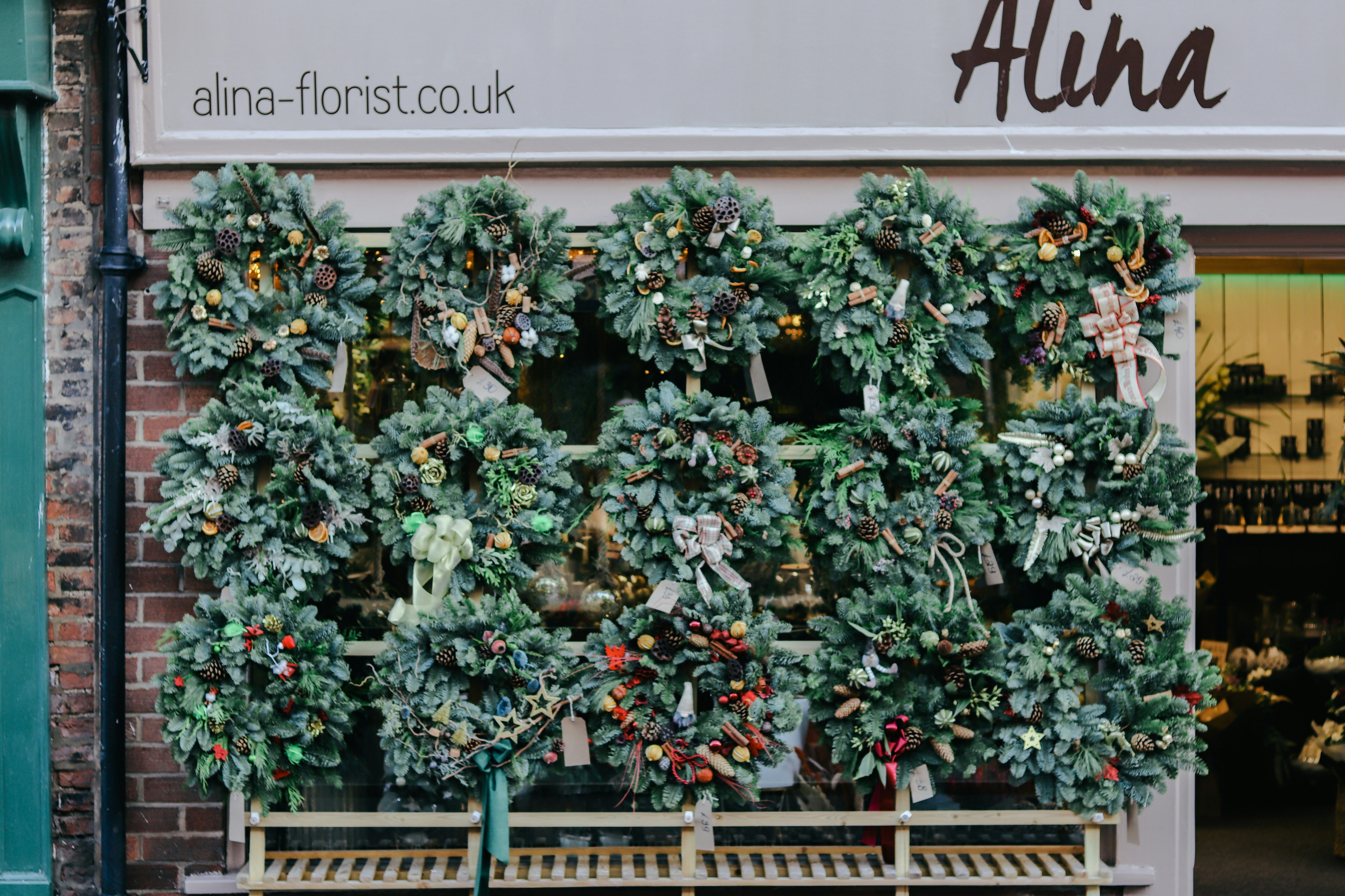 Verdant Curtain: Wreath Wall Framing Alina Florist's Storefront