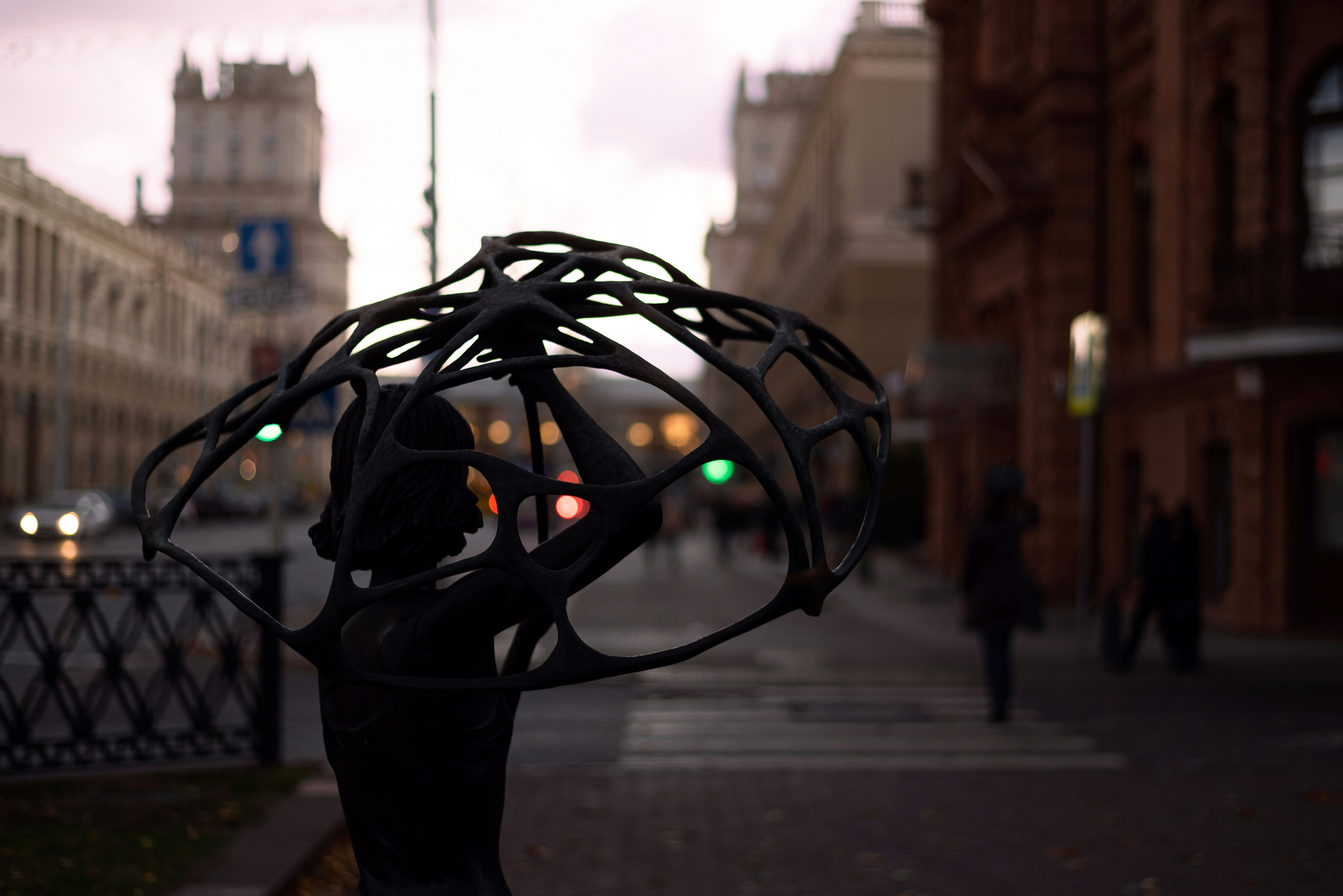 Lace-Sphere at Dusk: An Iron Orb Framing a Quiet City Street