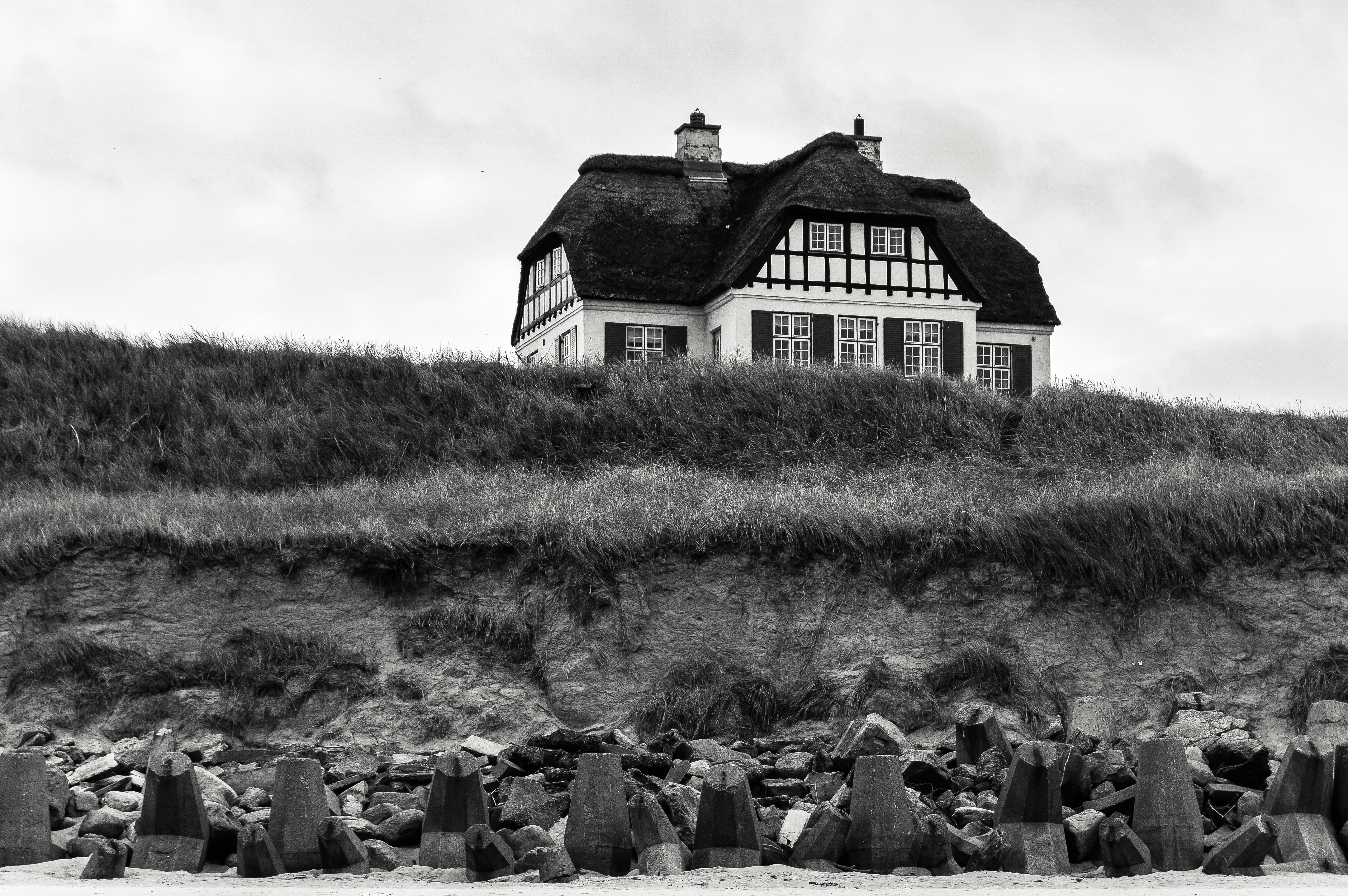 Cliffside Thatched Cottage in Monochrome: A Quiet Coastal Portrait