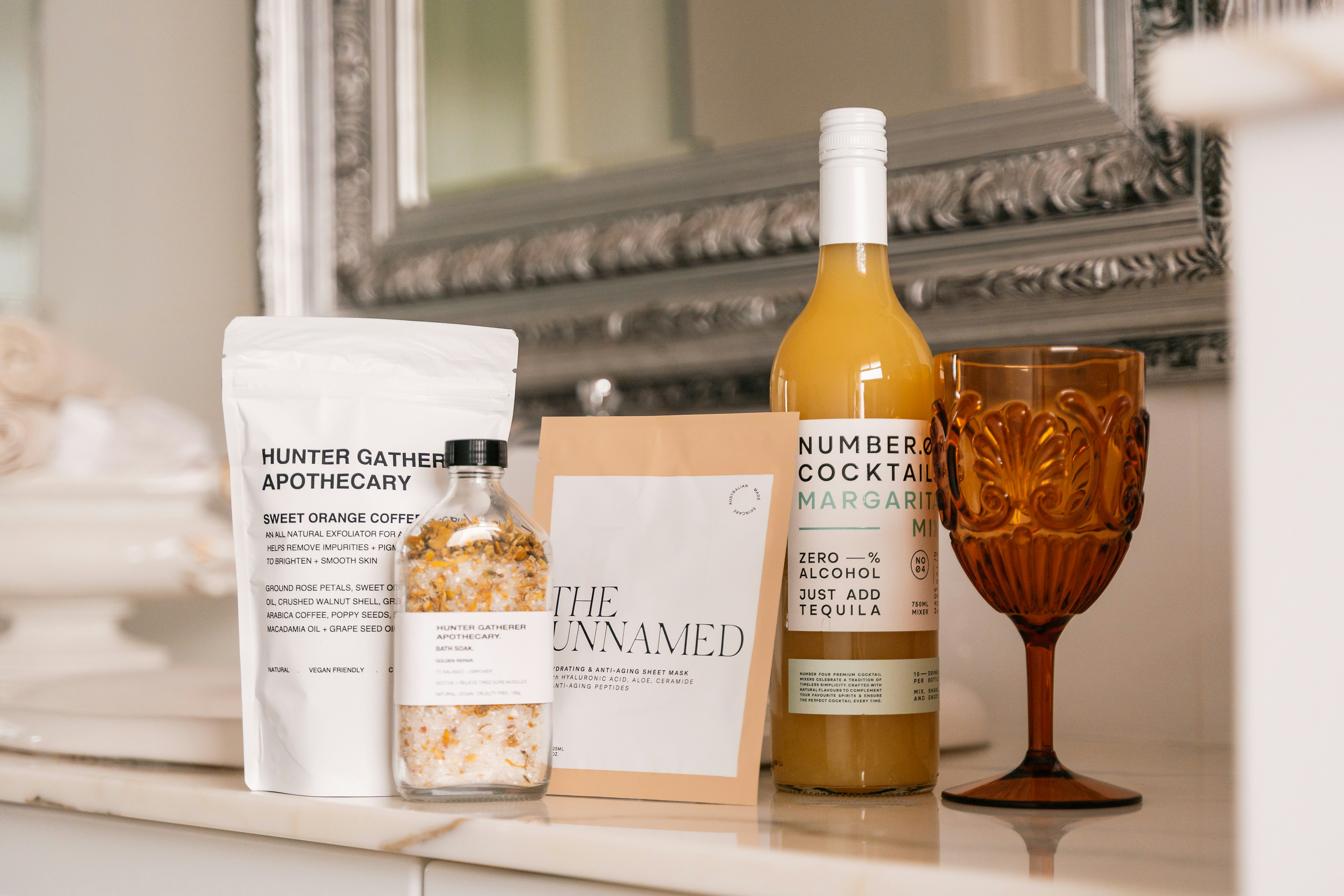 Bottle lineup on a marble counter with amber glass and packaging
