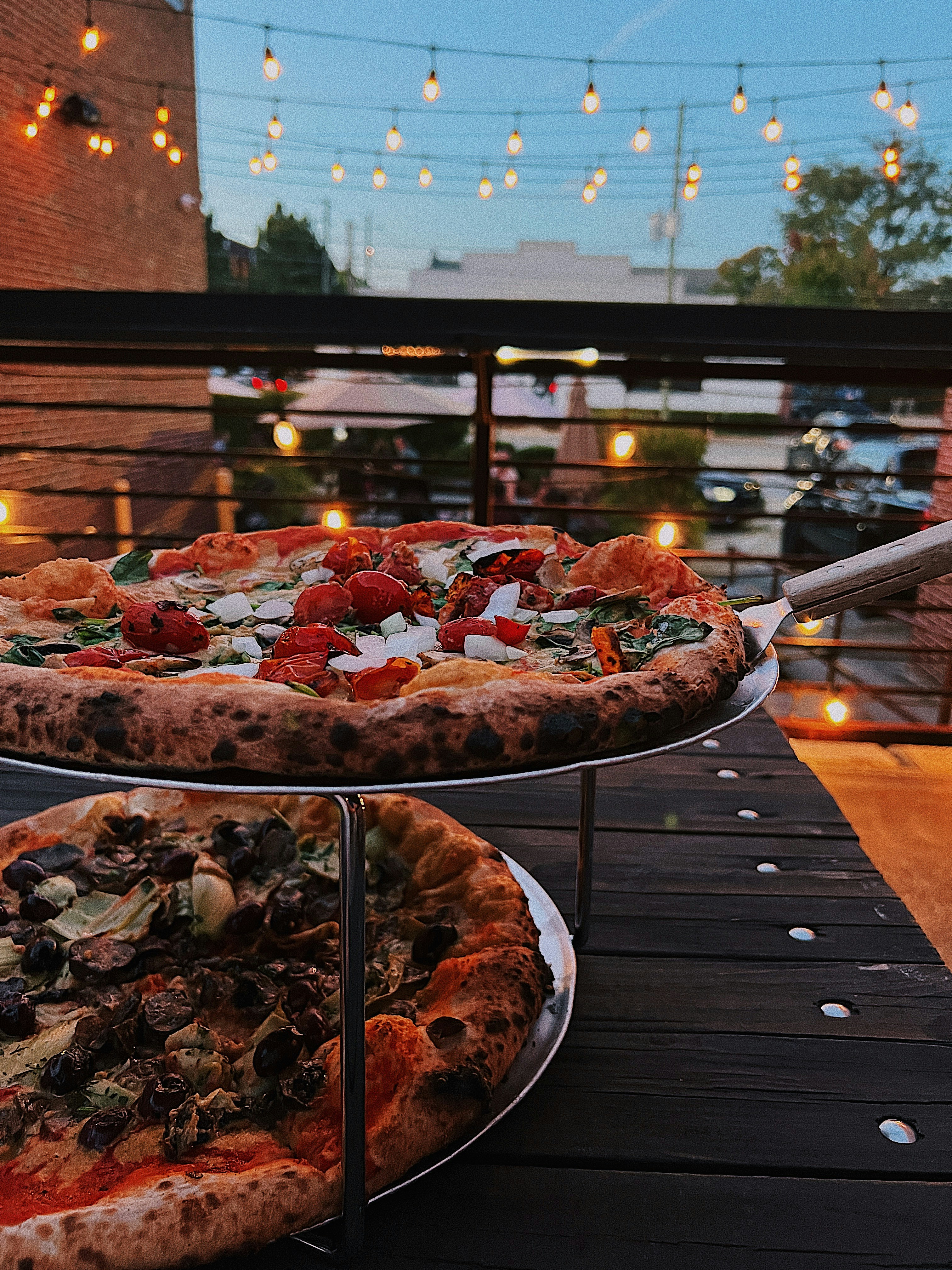 Elevated Pizza Feast Under String Lights