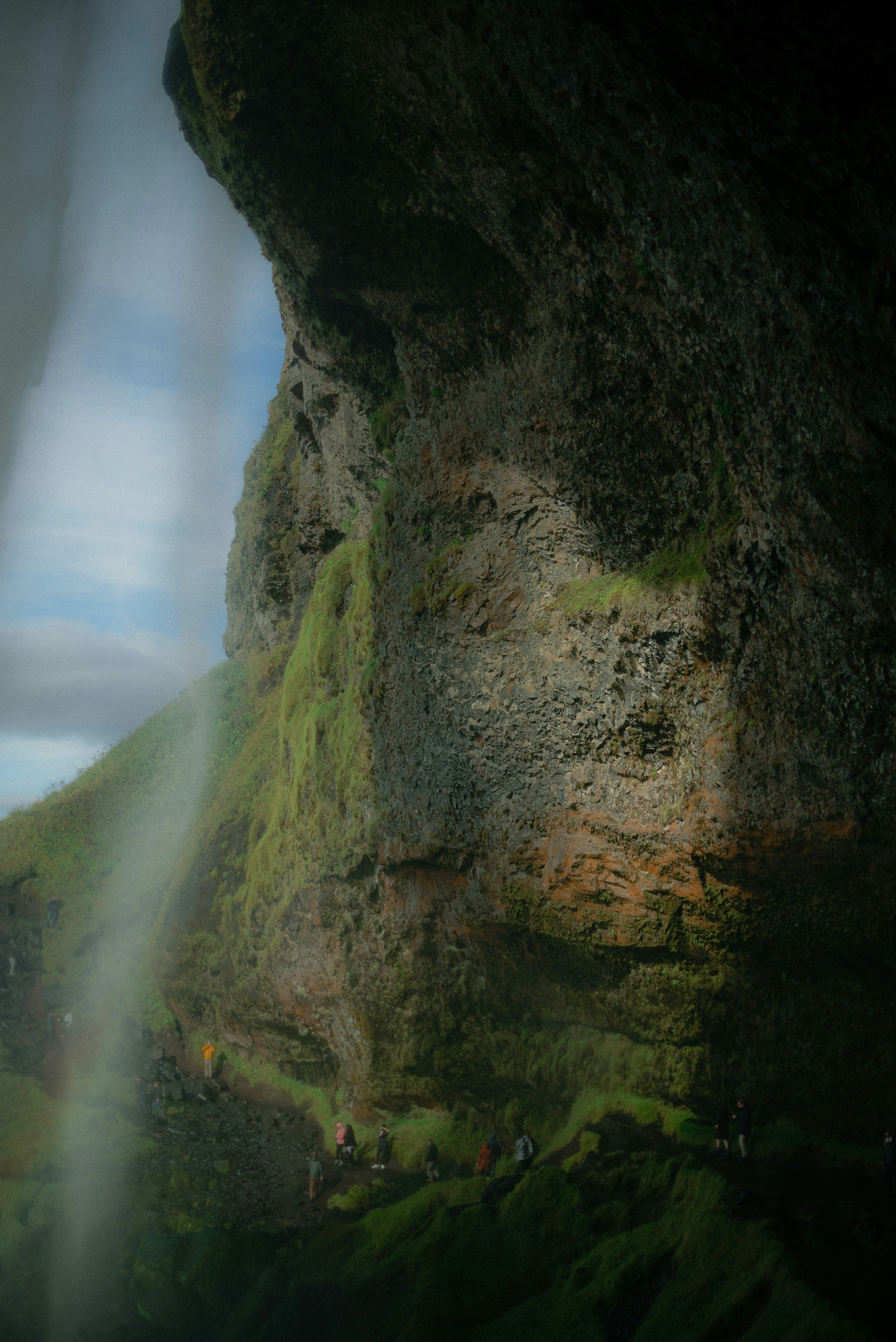 A group of people walking on a path between cliffs photo – Free Iceland ...