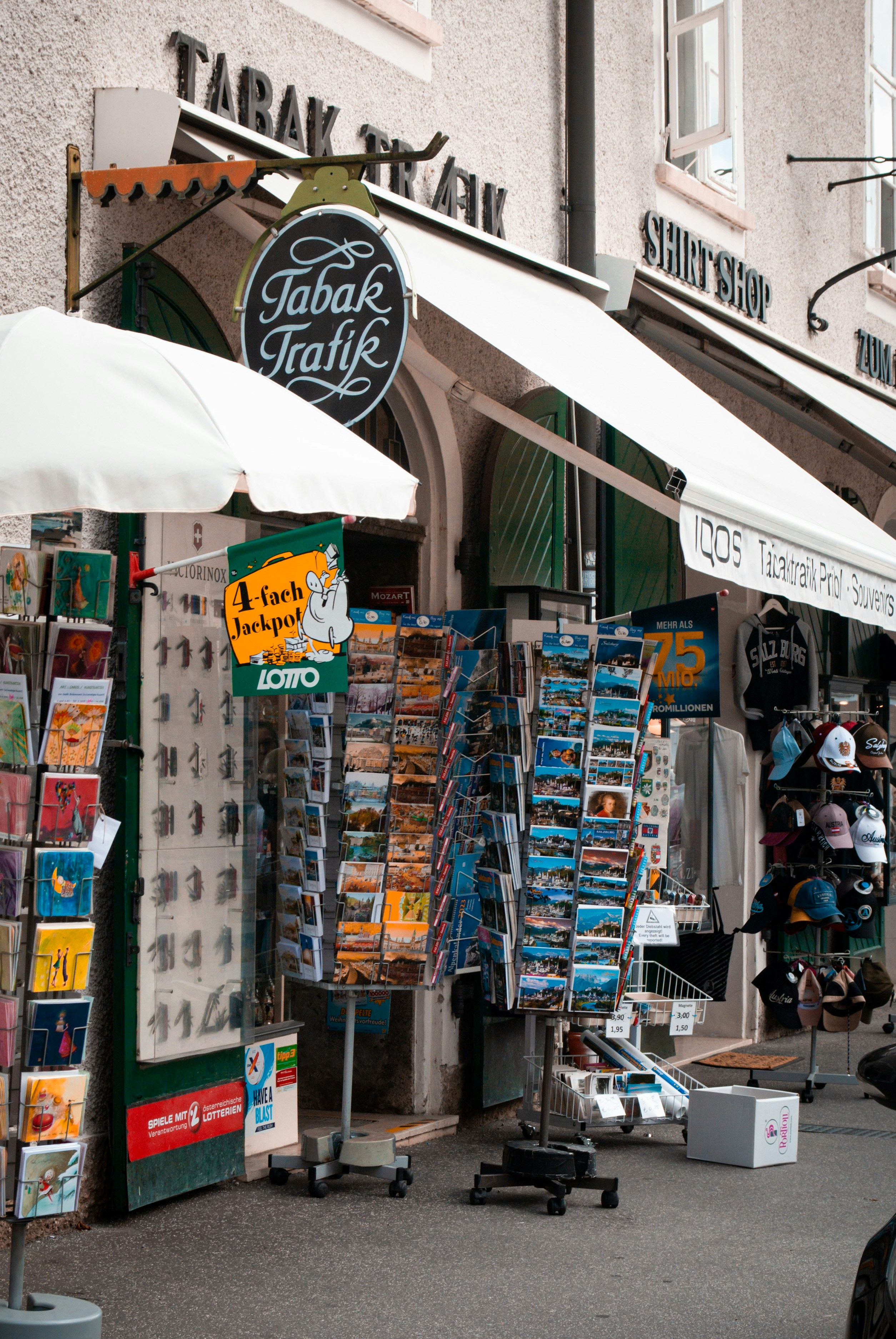 Streetfront of a Tourist Newsstand with Postcard Racks under Awnings