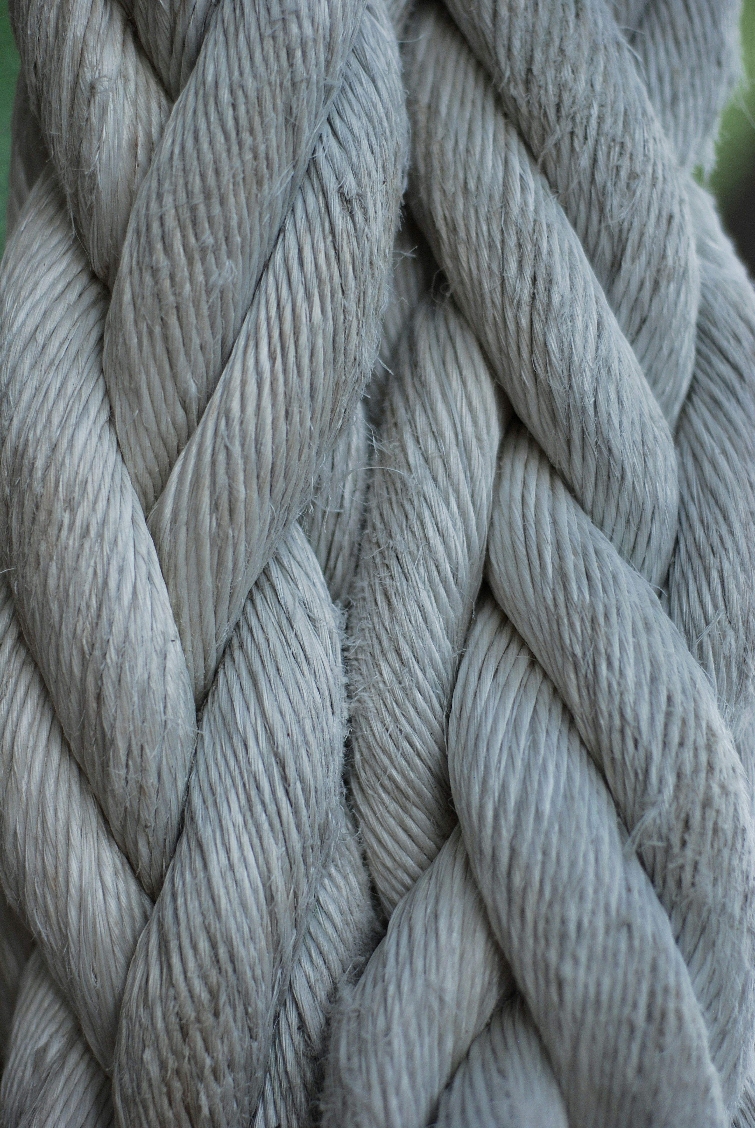 Close-up of thick, gray rope showcasing intricate braiding and texture details.