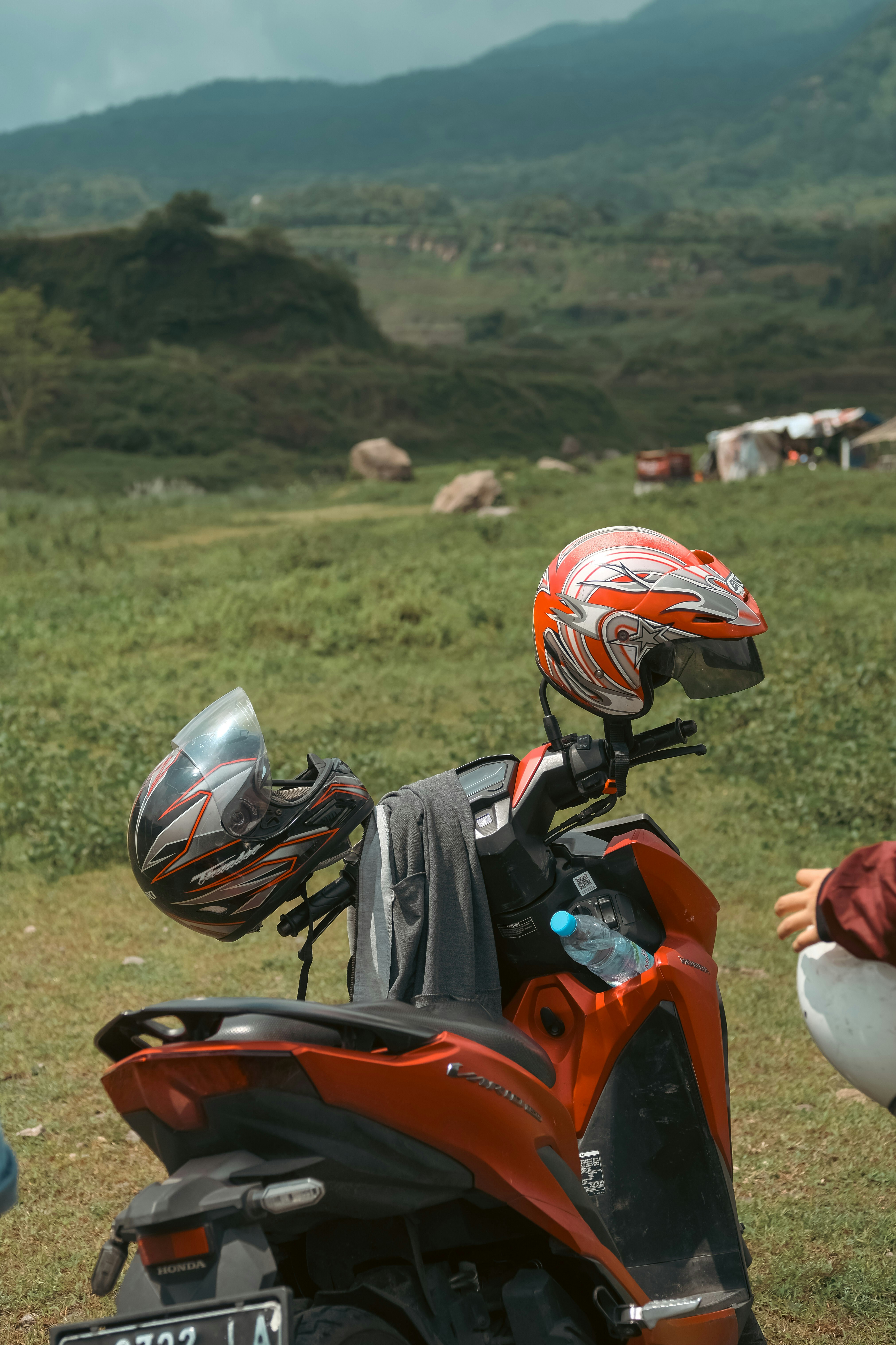 Rural Rest Stop: An Orange Scooter Pauses Amid Rolling Fields