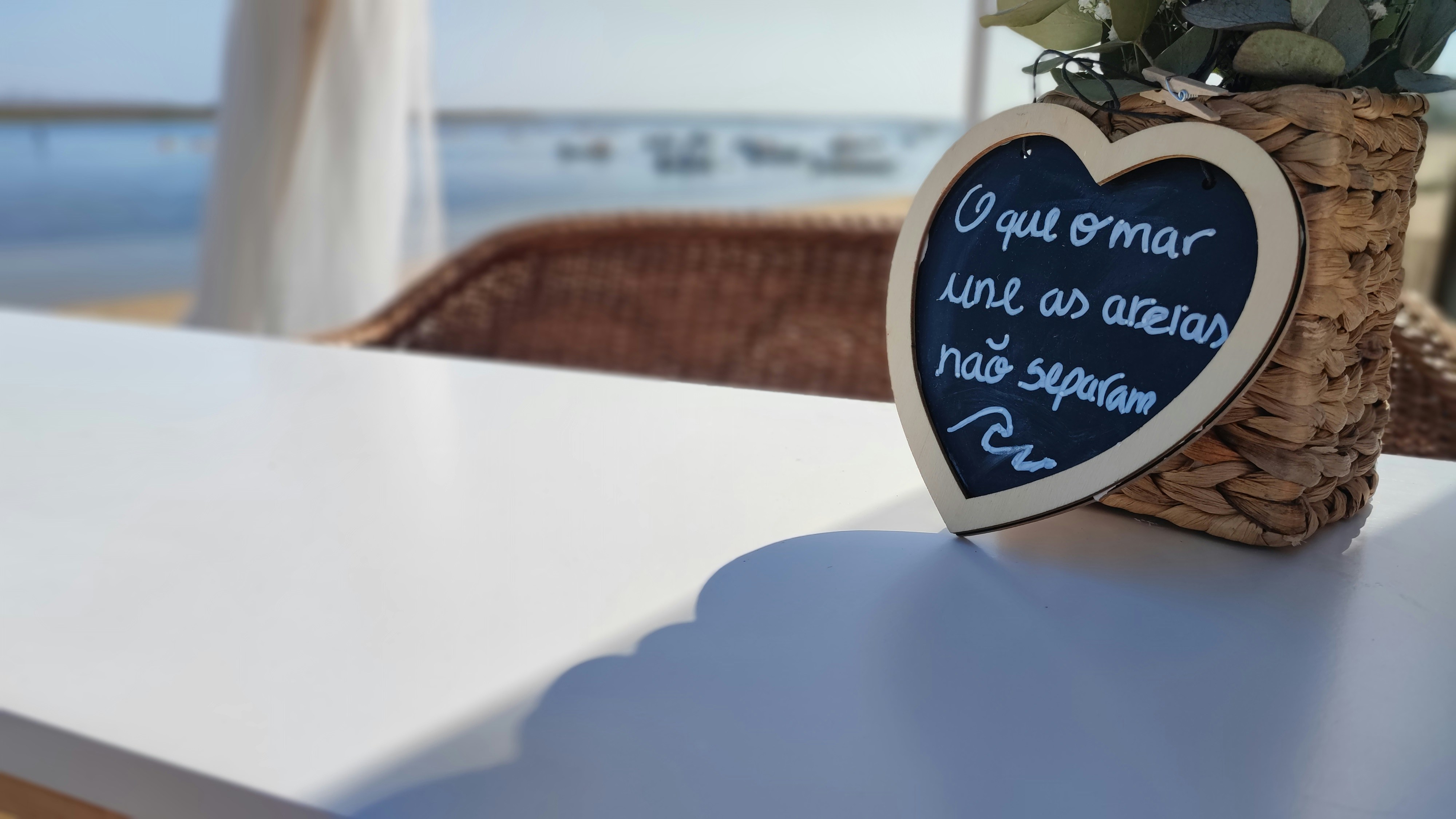Heart-Shaped Chalkboard on a Seaside Café Terrace