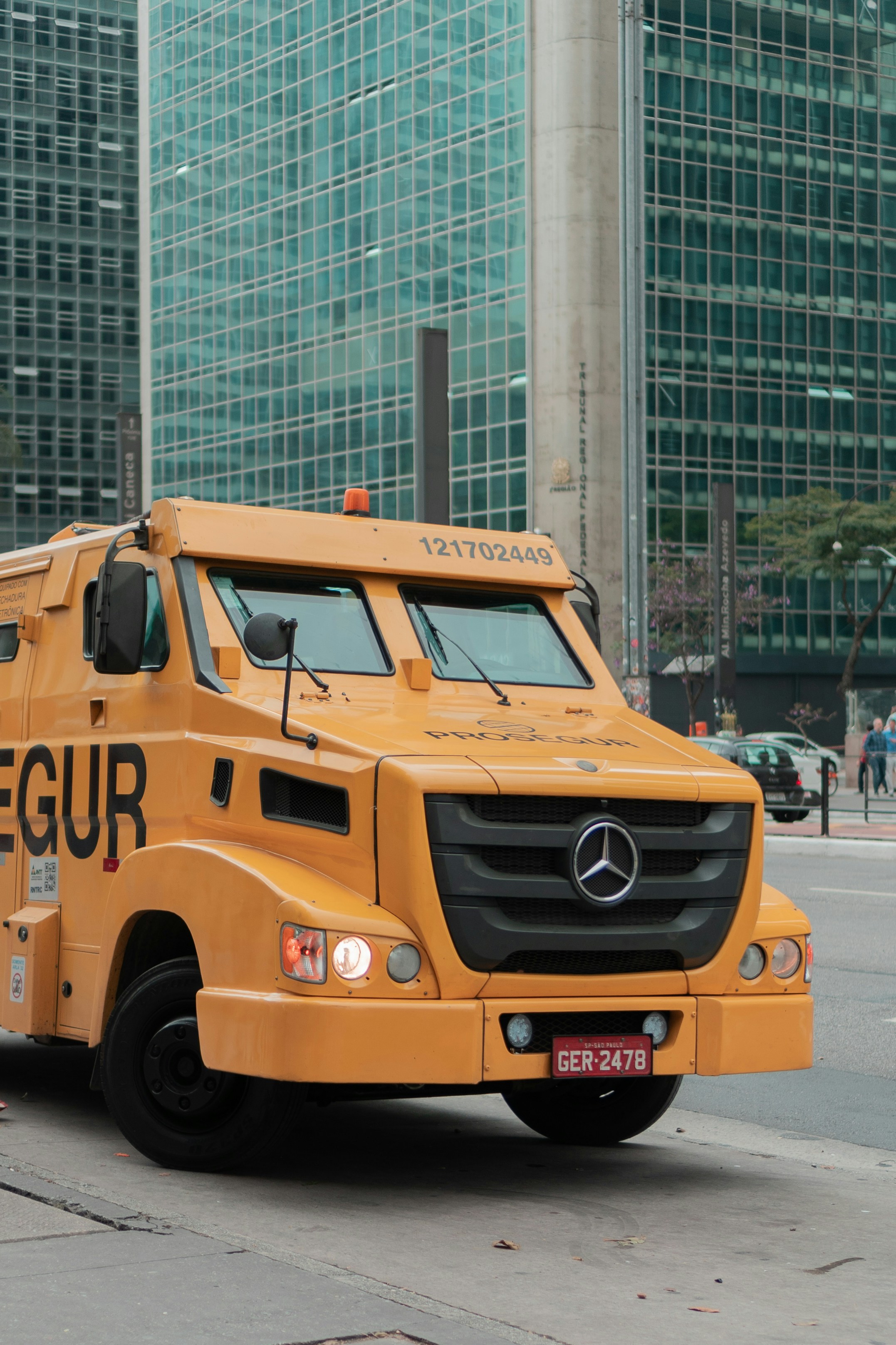 Urban Amber: A Fire Engine Stands Bold Against Glass Towers