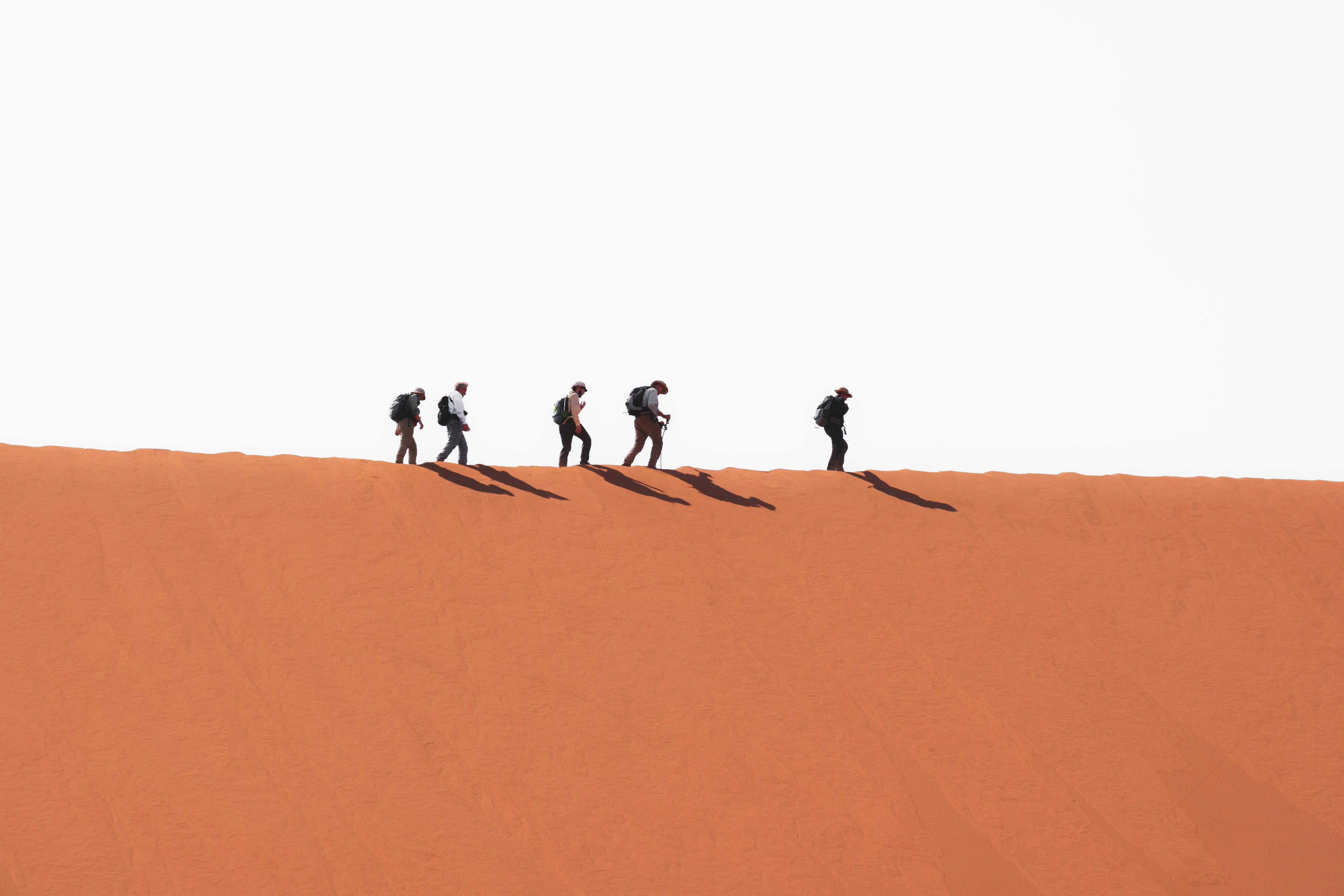 A group of people walking on sand photo – Free Namibia Image on Unsplash